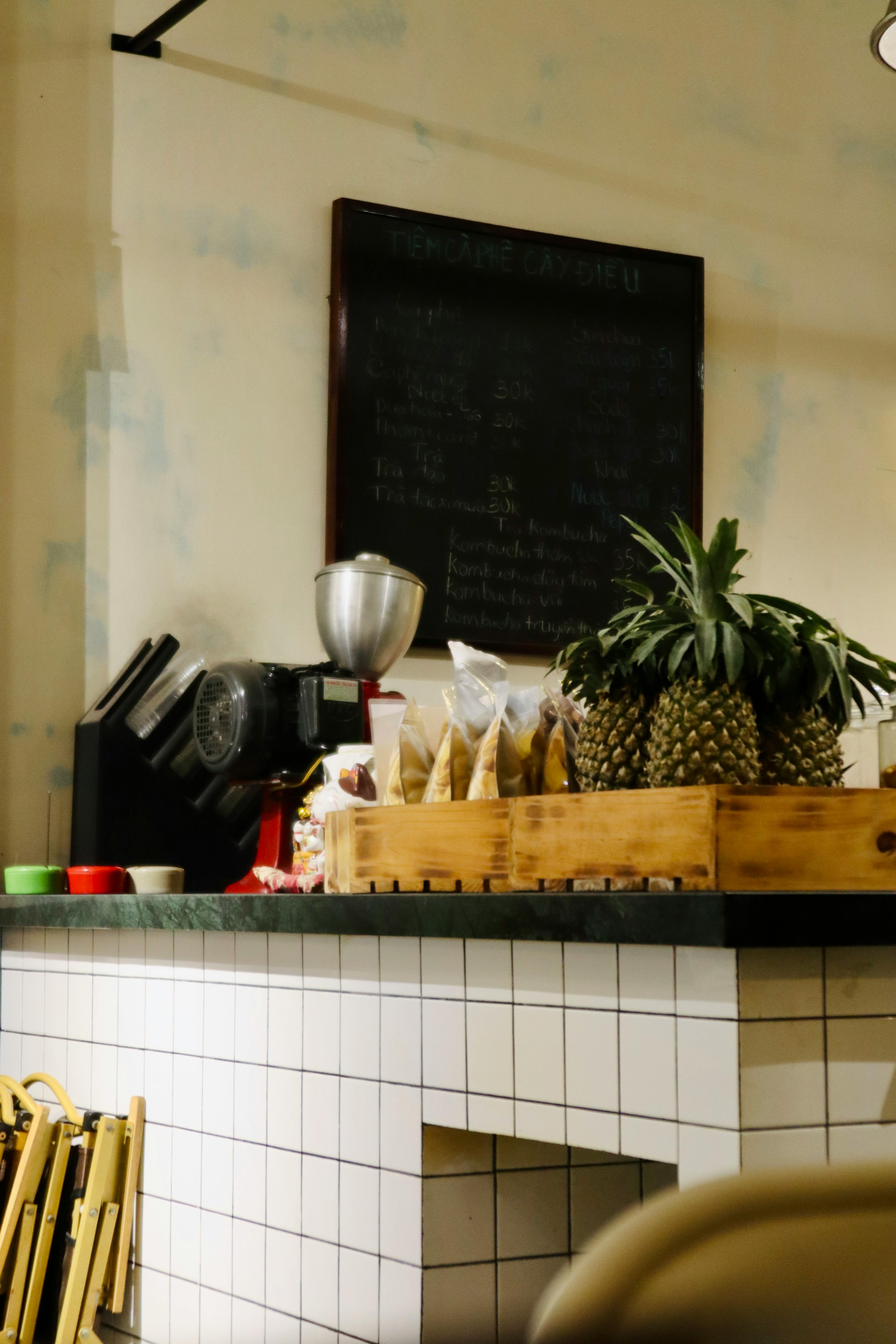 Cozy Café Counter with Fresh Pineapples · Free Stock Photo