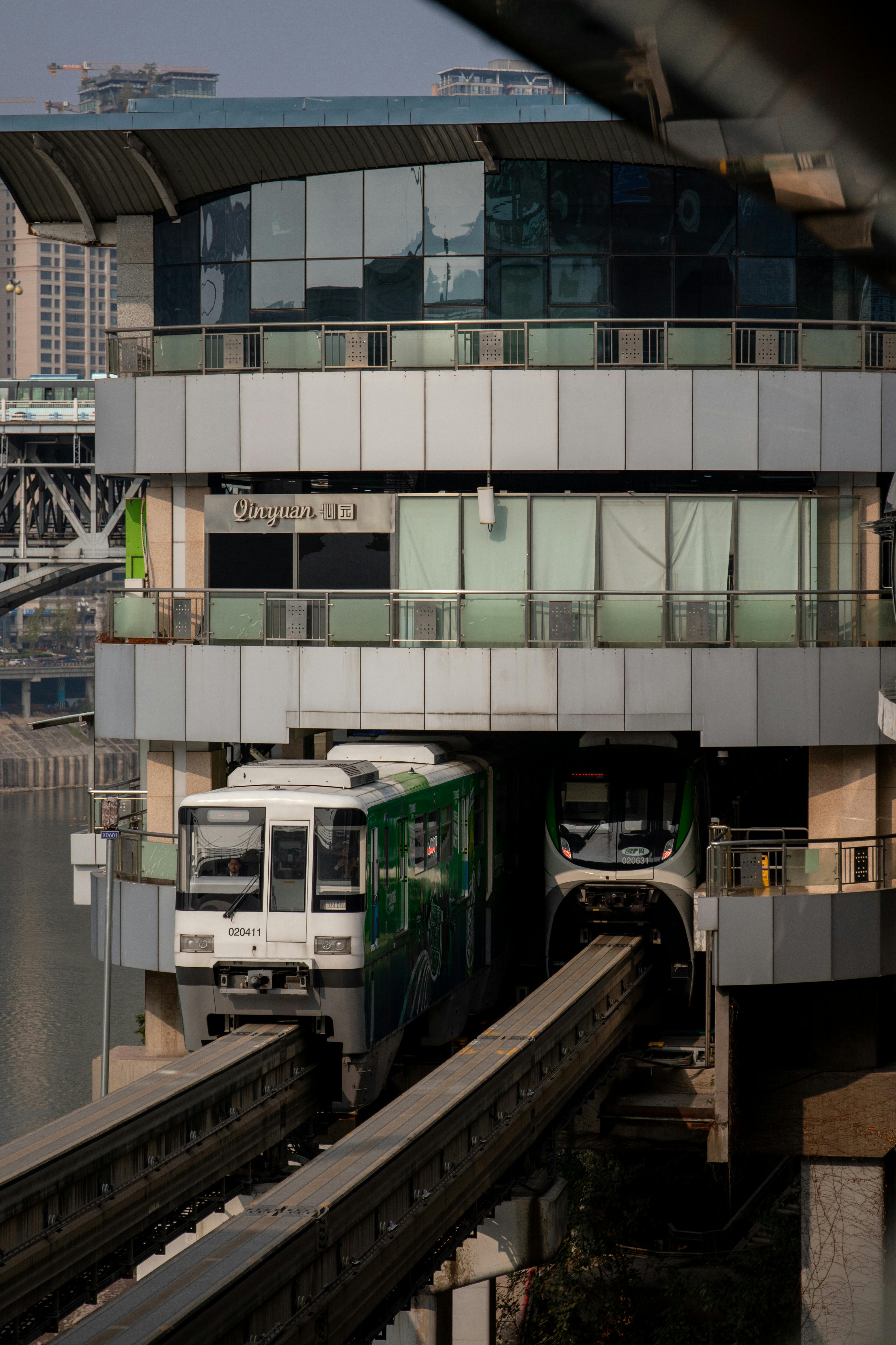 Modern Urban Monorail Passing Through Building · Free Stock Photo