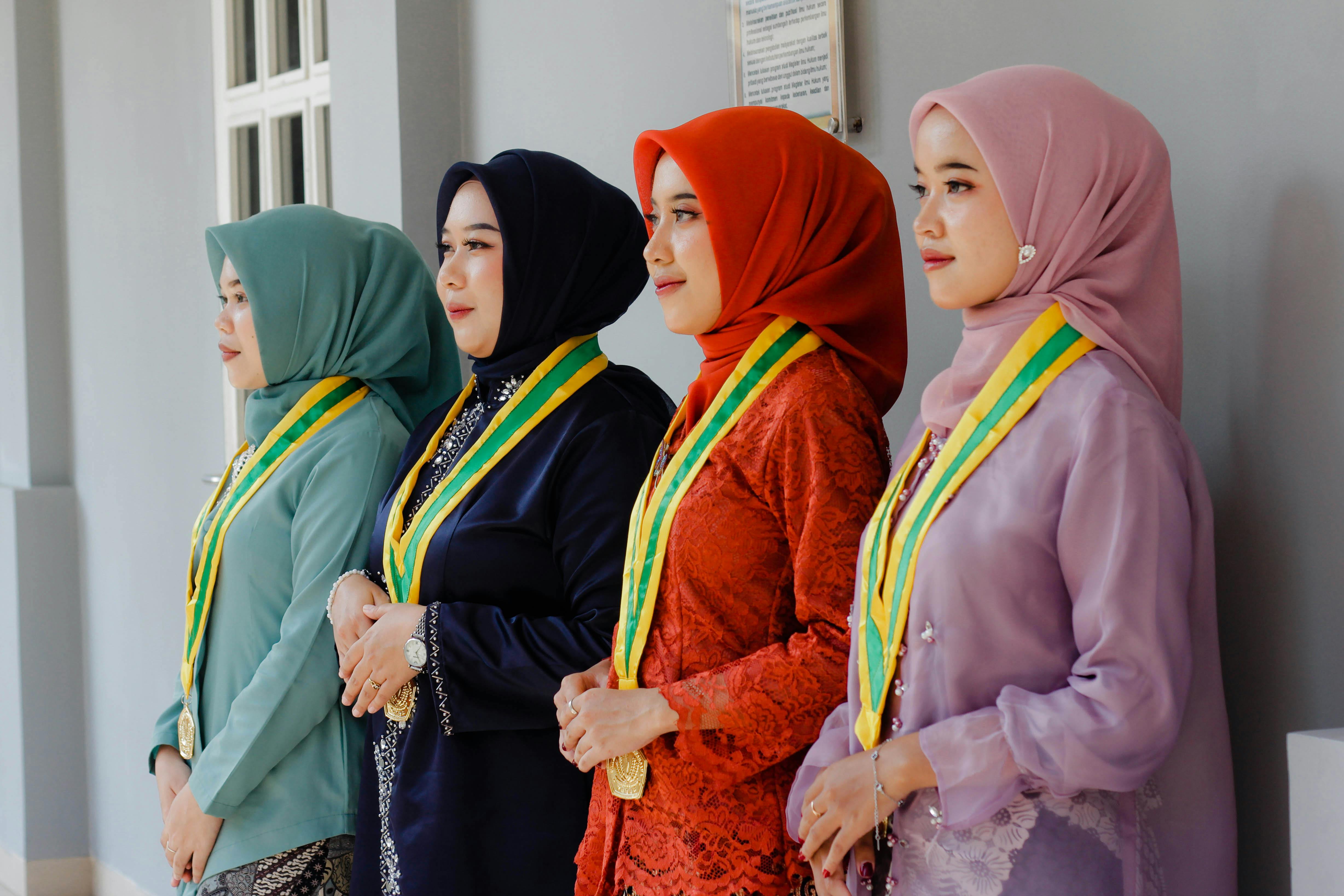 Graduation ceremony with four young women in hijabs · Free Stock Photo