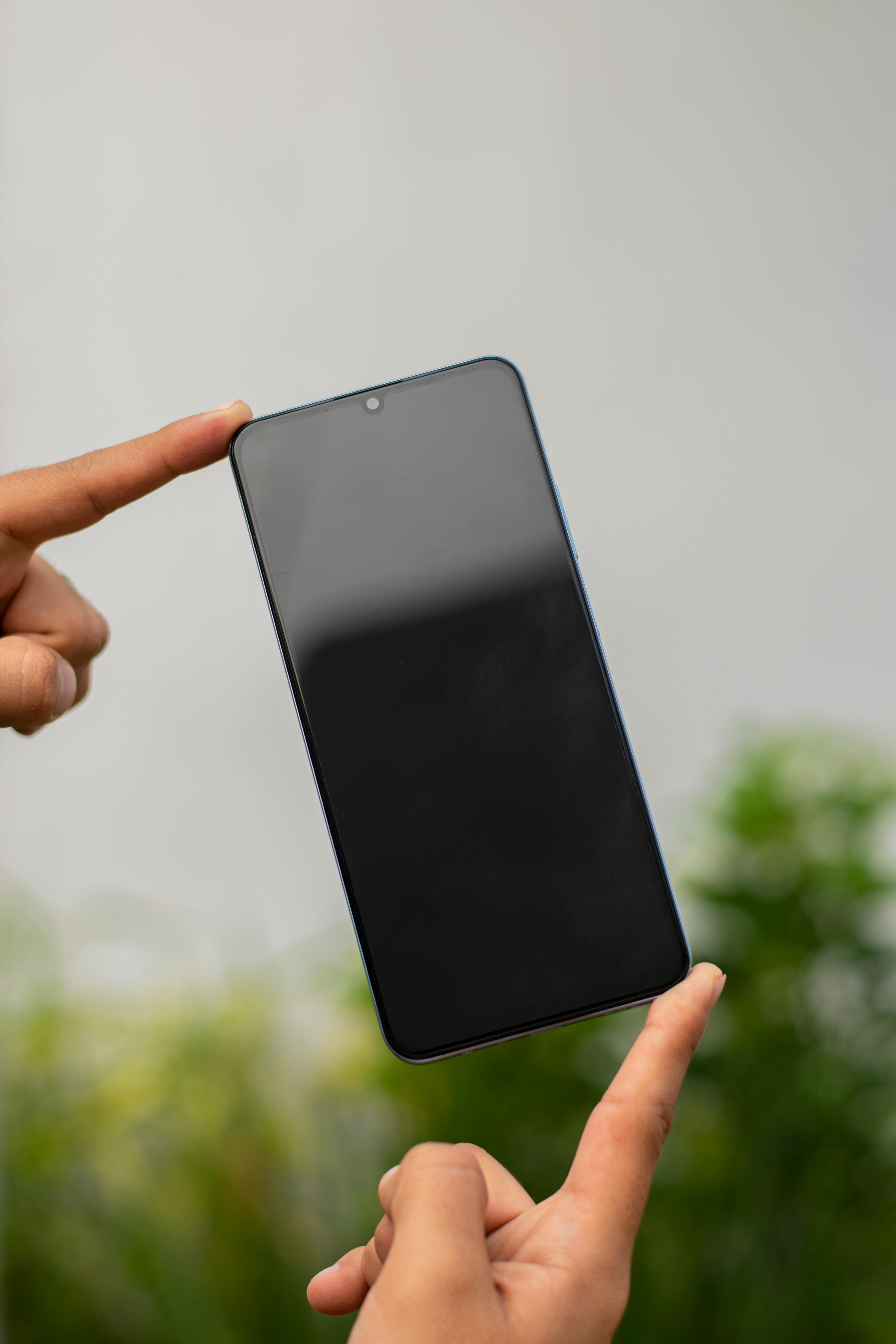 Close-up of Smartphone Balanced Between Hands · Free Stock Photo