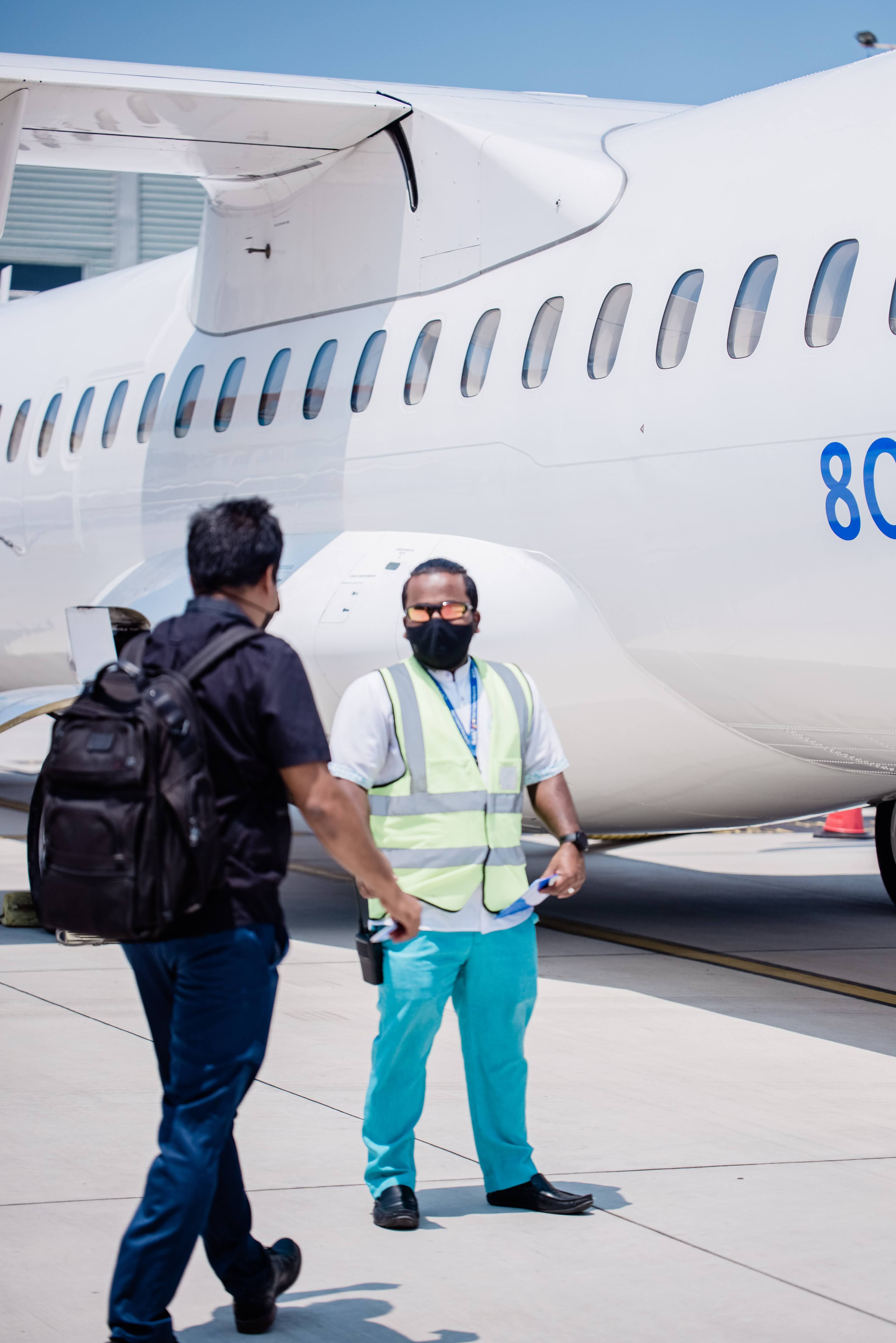 Airport Ground Crew with Passenger Interaction · Free Stock Photo