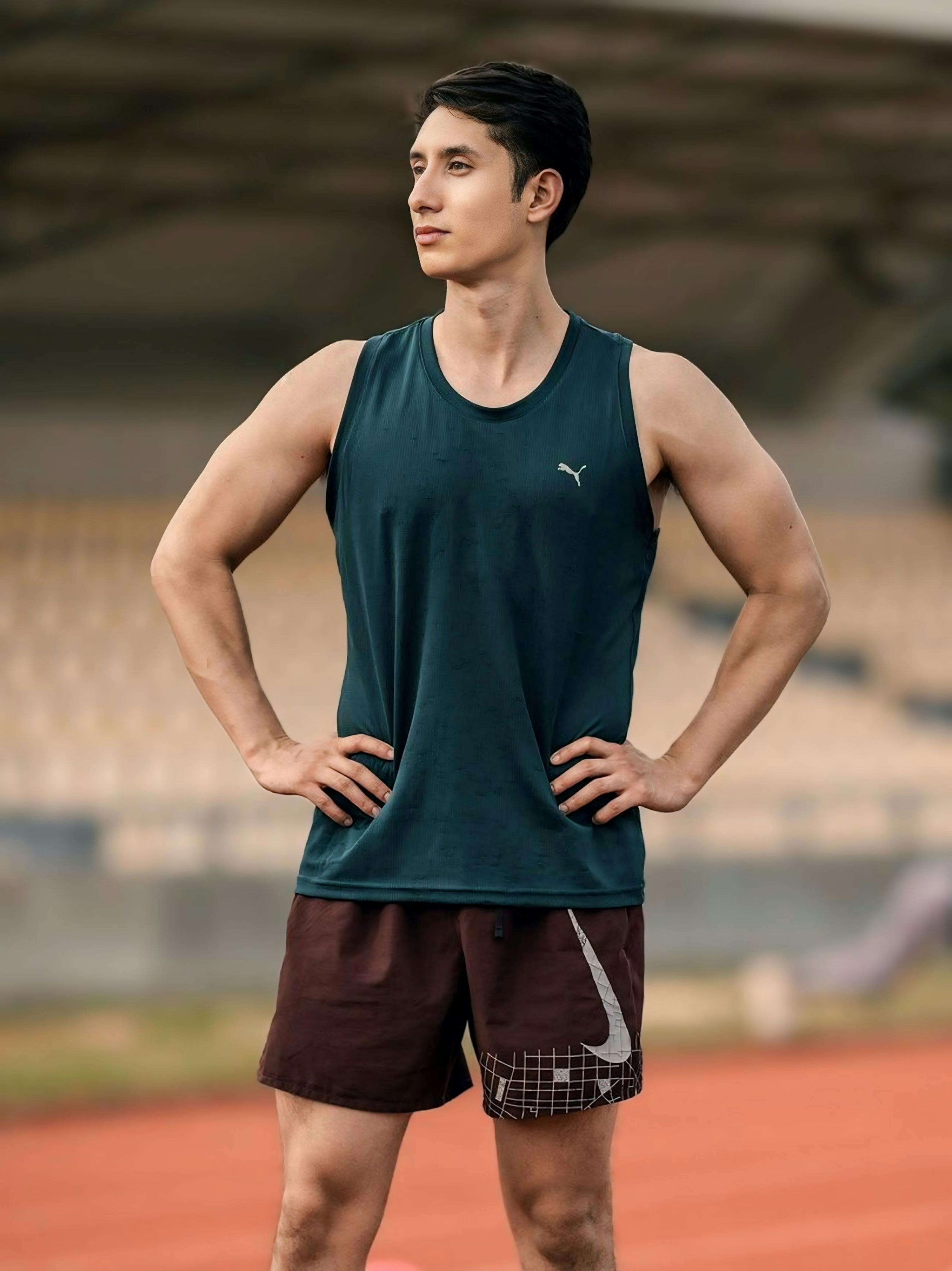 Athletic Male Runner Posing on Track · Free Stock Photo