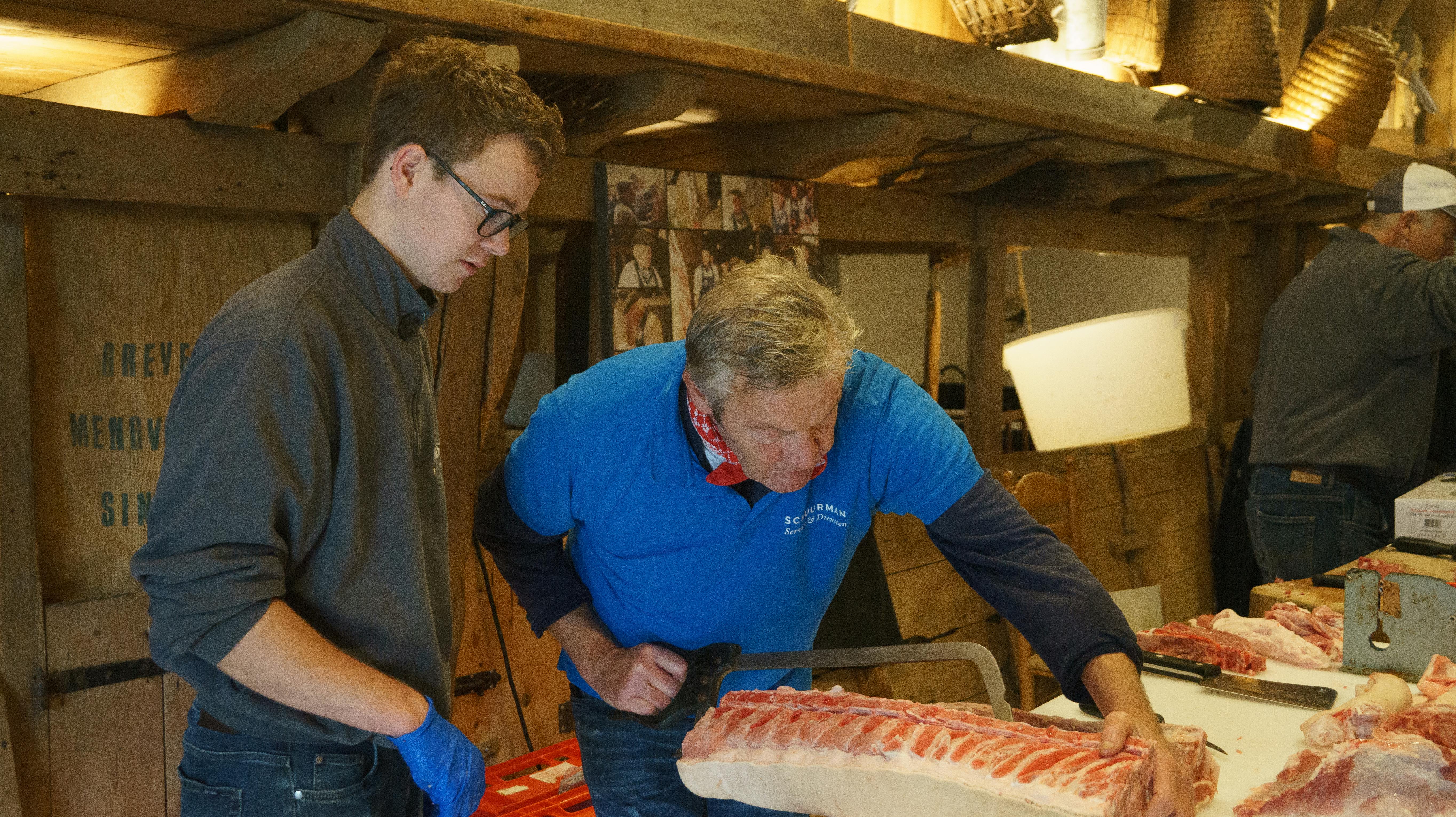 Butchers Preparing Meat Indoors with Expertise · Free Stock Photo