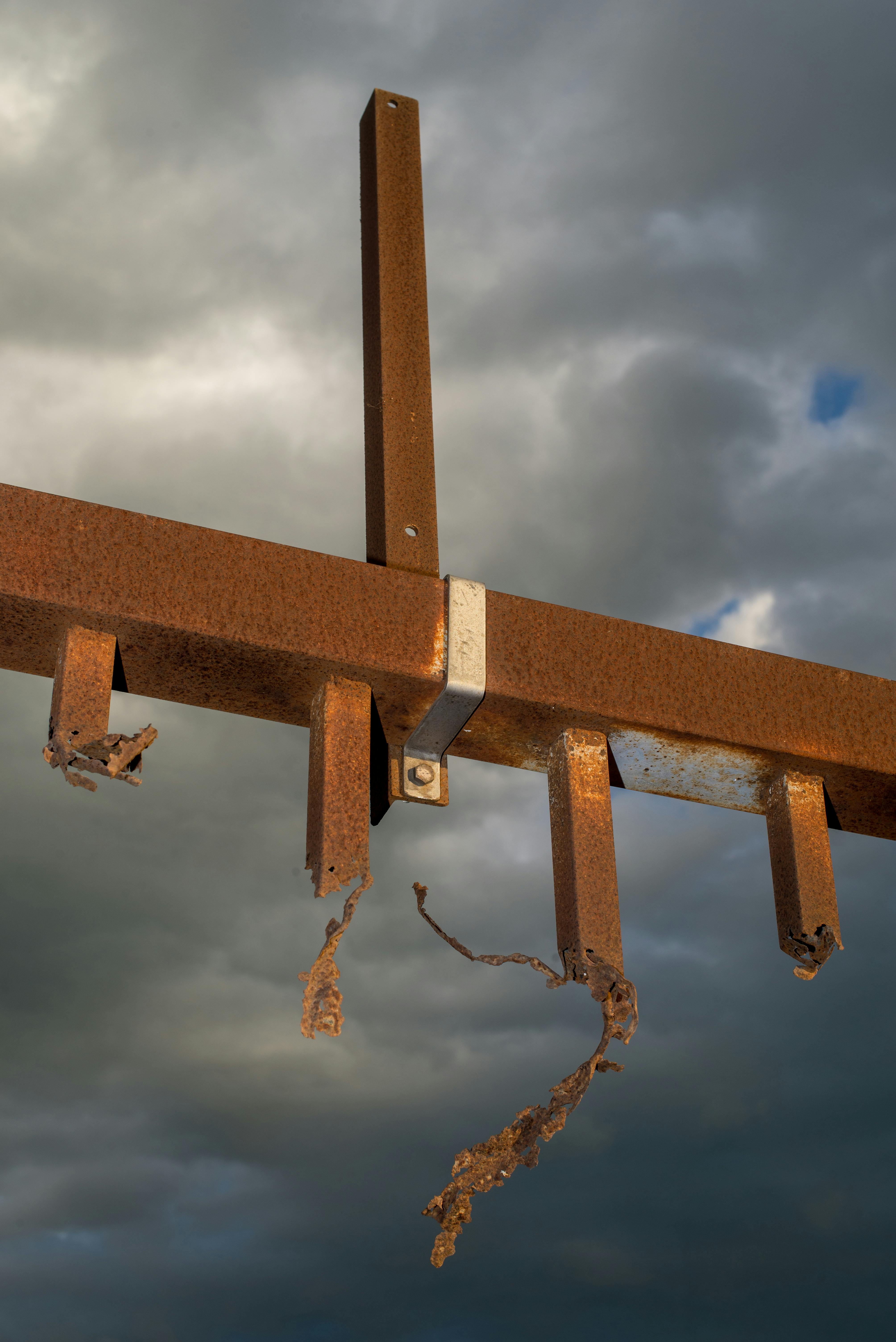 Rusty Metal Structure Against Clouded Sky · Free Stock Photo