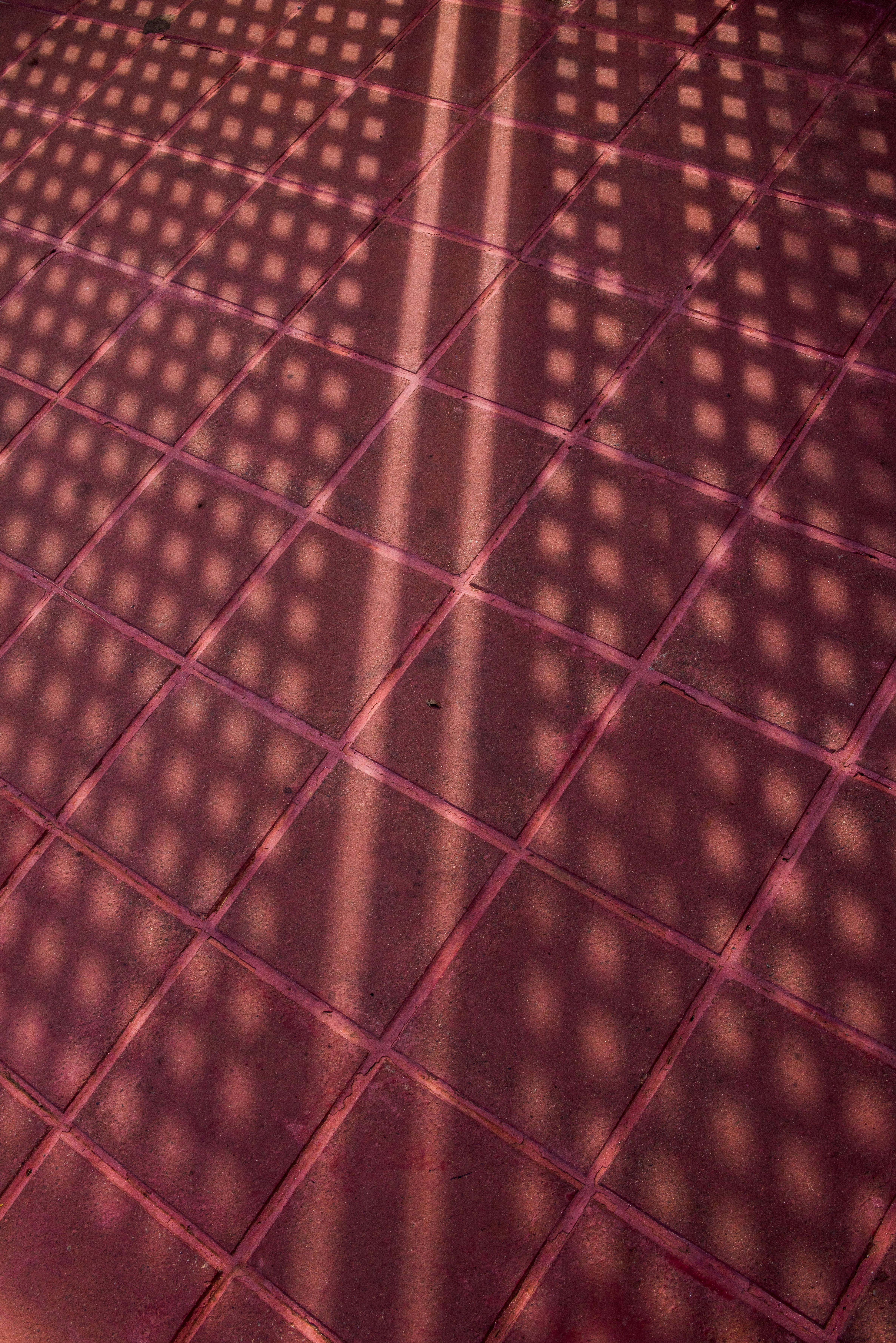 Geometric shadows on patterned tiled floor · Free Stock Photo
