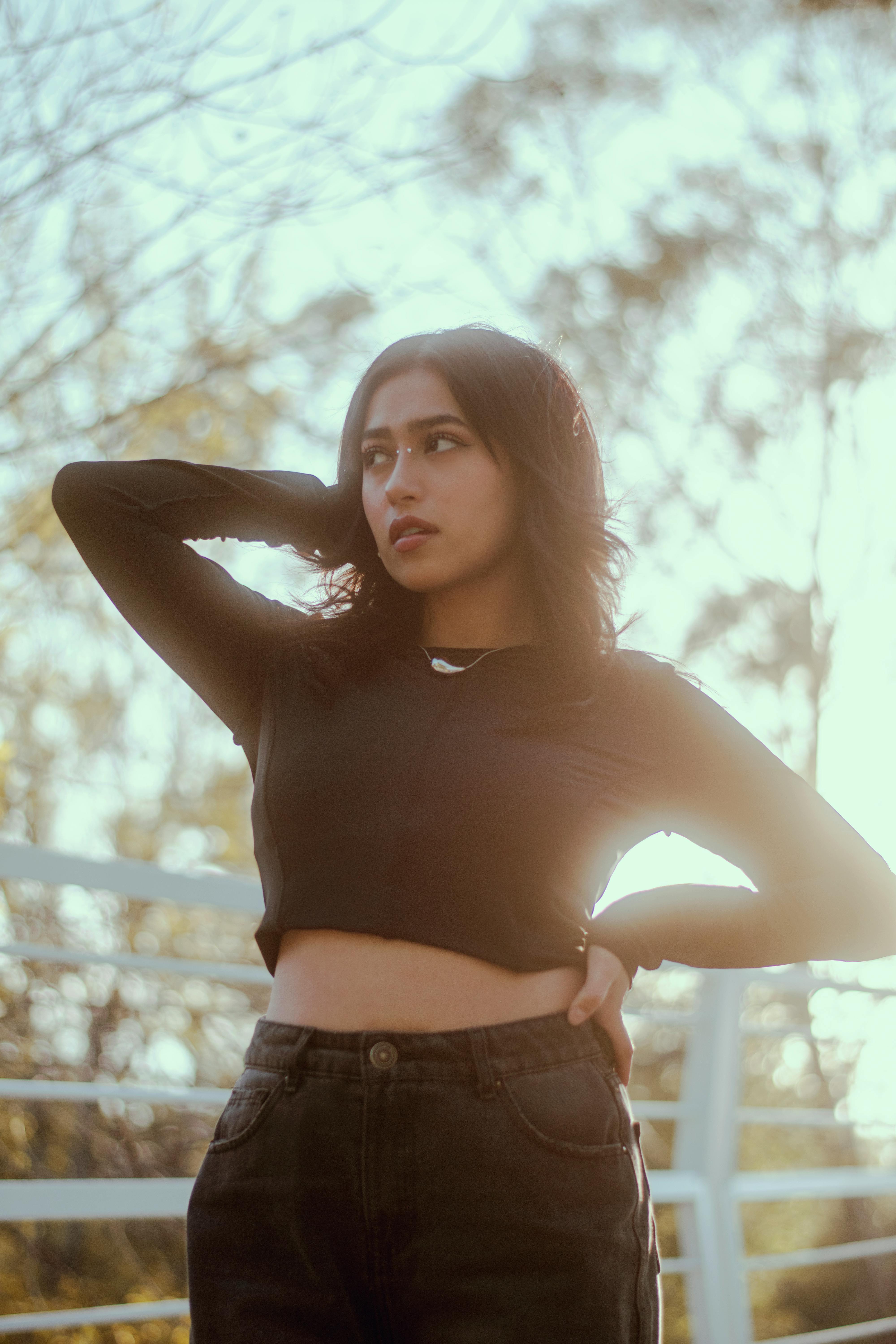 Sunlit Portrait of a Young Woman Outdoors · Free Stock Photo