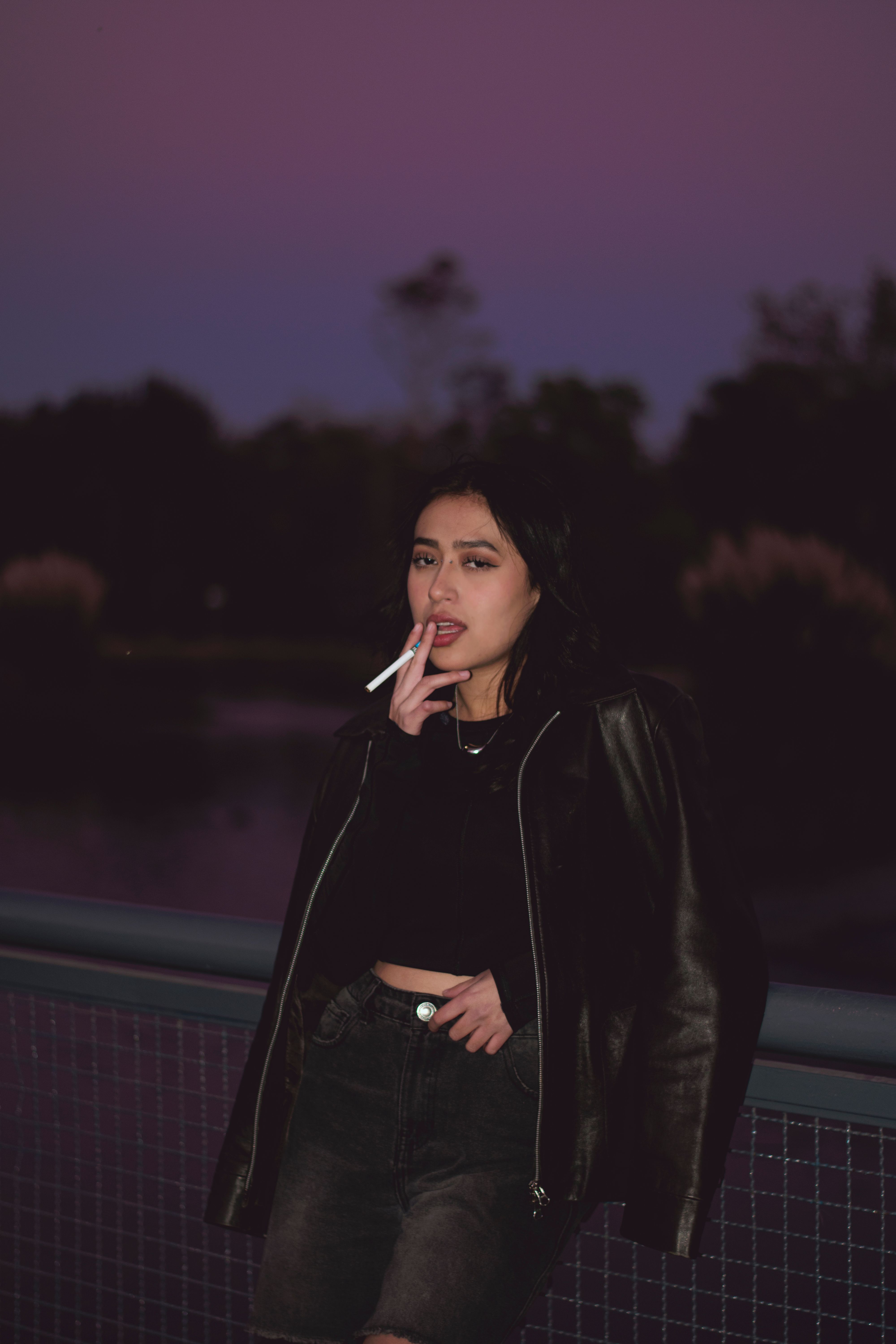 Moody Night Portrait of Young Woman Smoking · Free Stock Photo