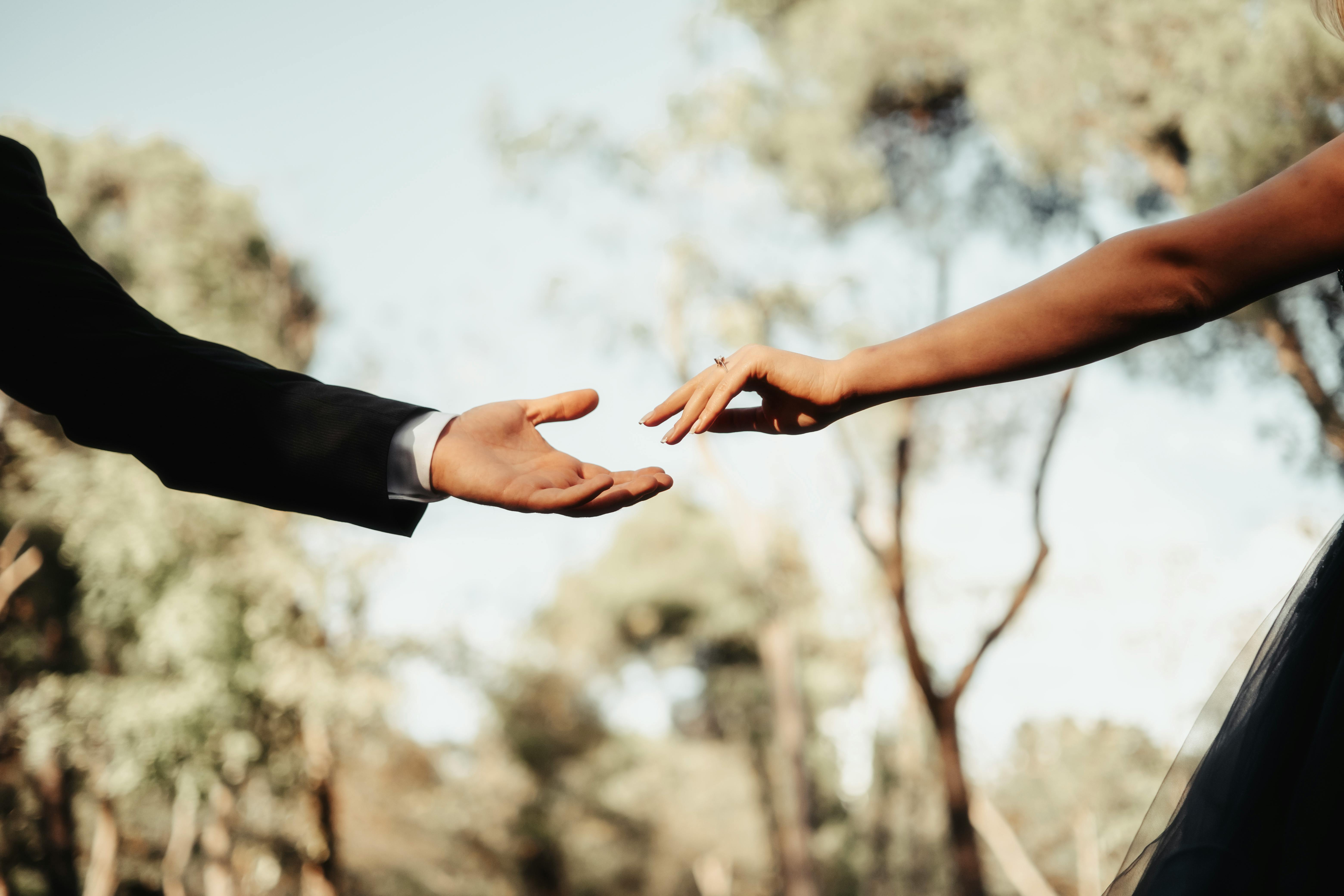 Romantic Outdoor Gesture Captured at Sunset · Free Stock Photo