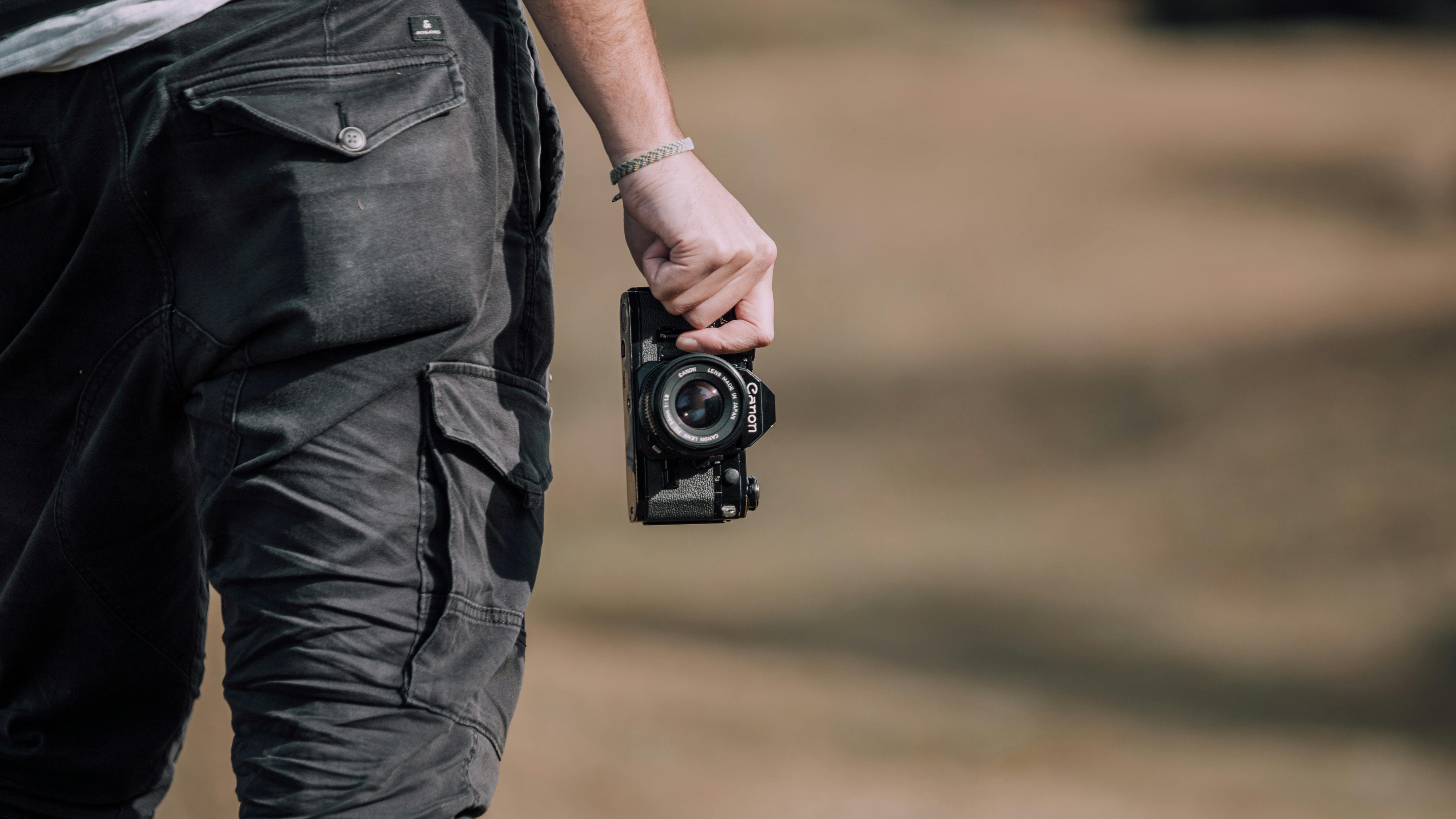 Close-up of Person Holding a Vintage Camera Outdoors · Free Stock Photo