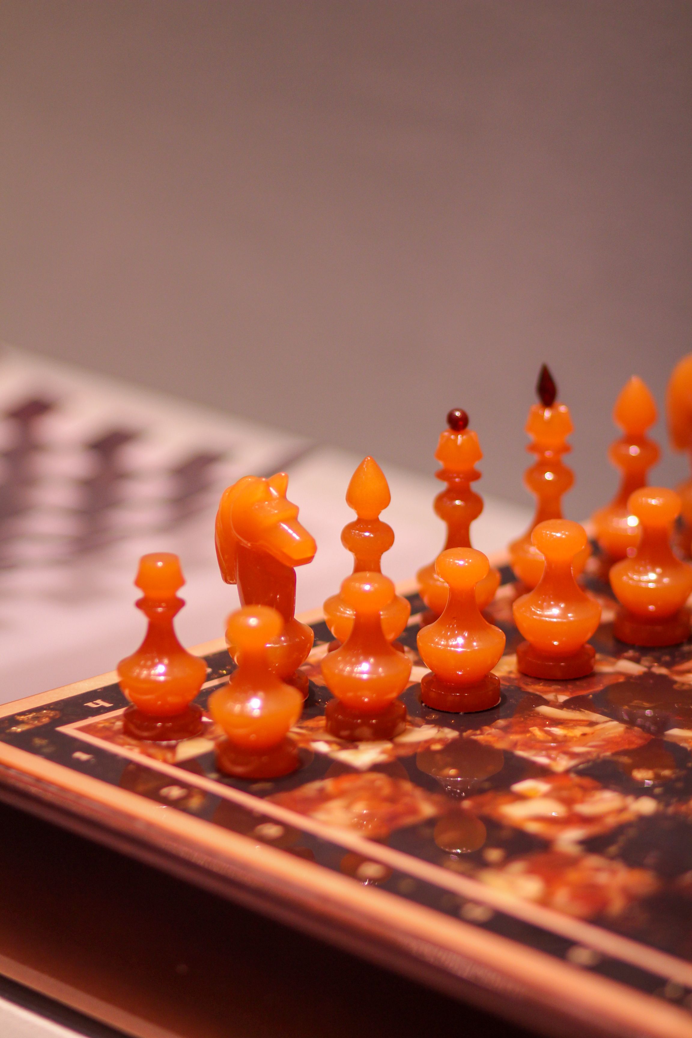 Close-up of Amber Chess Pieces on Board · Free Stock Photo