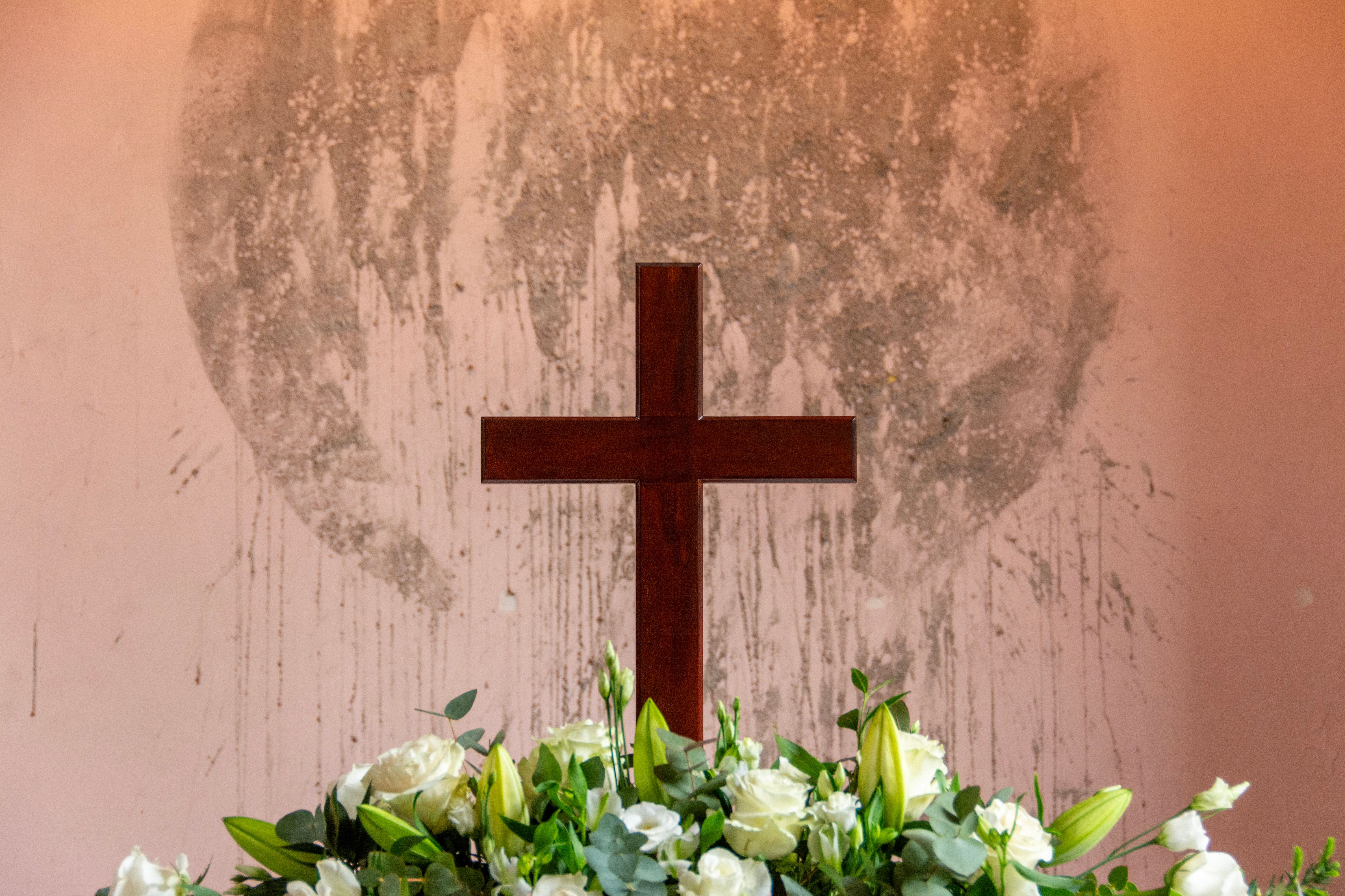 Wooden Cross with Floral Arrangement in Chapel · Free Stock Photo