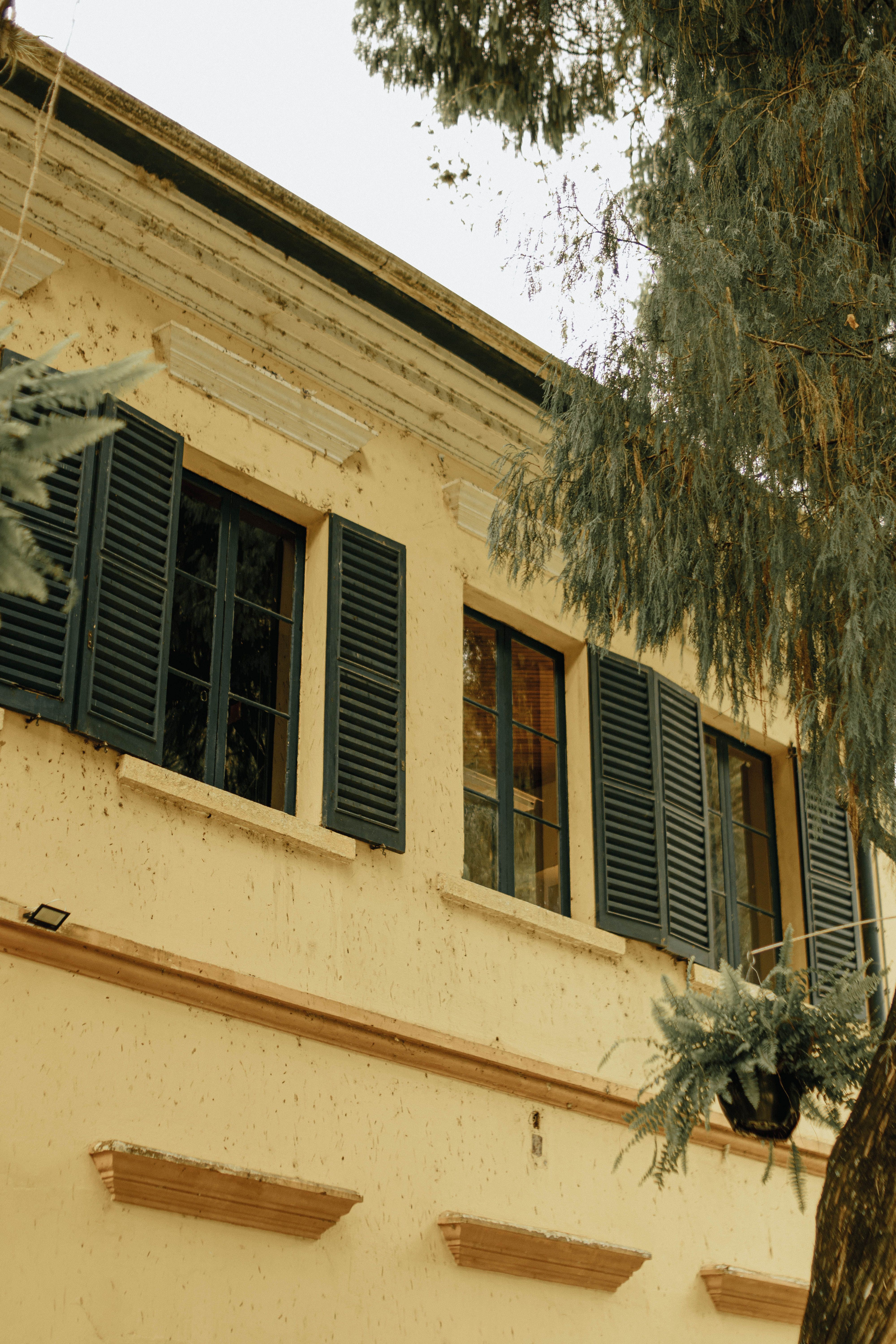 Elegant Old Building with Shuttered Windows · Free Stock Photo
