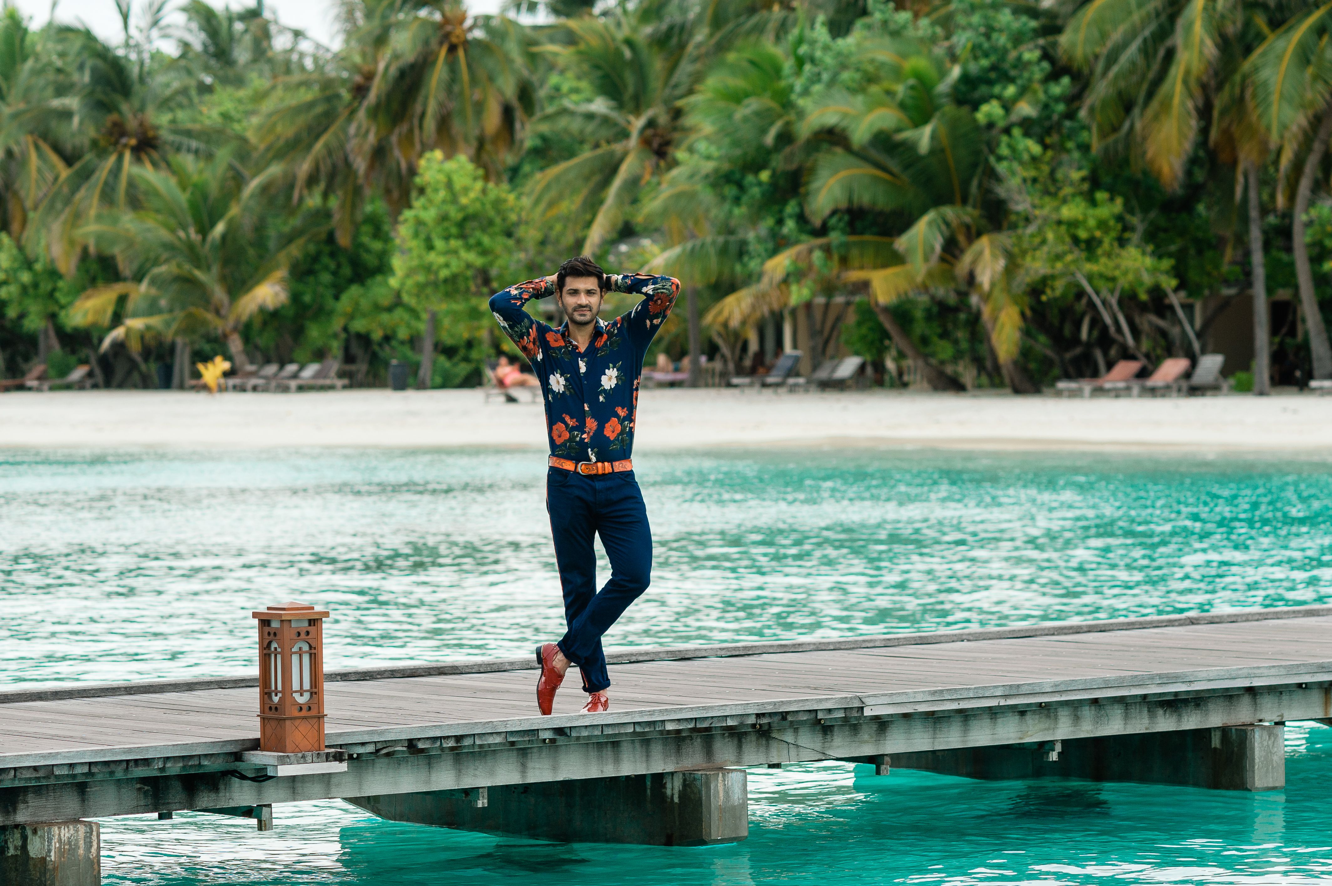 Stylish Man Posing on Maldives Beach Pier · Free Stock Photo