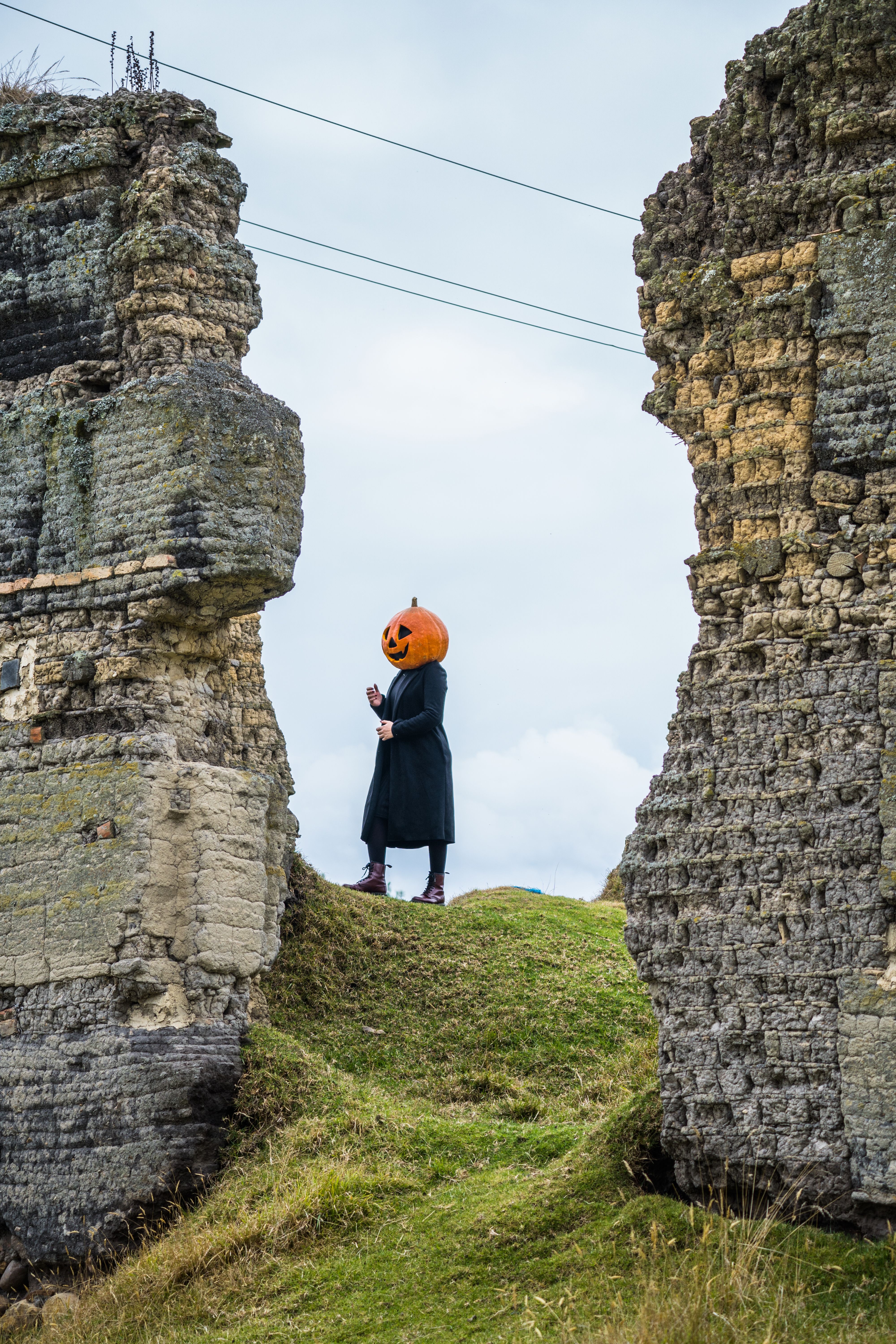 Mysterious Figure with Pumpkin Head Among Ruins · Free Stock Photo