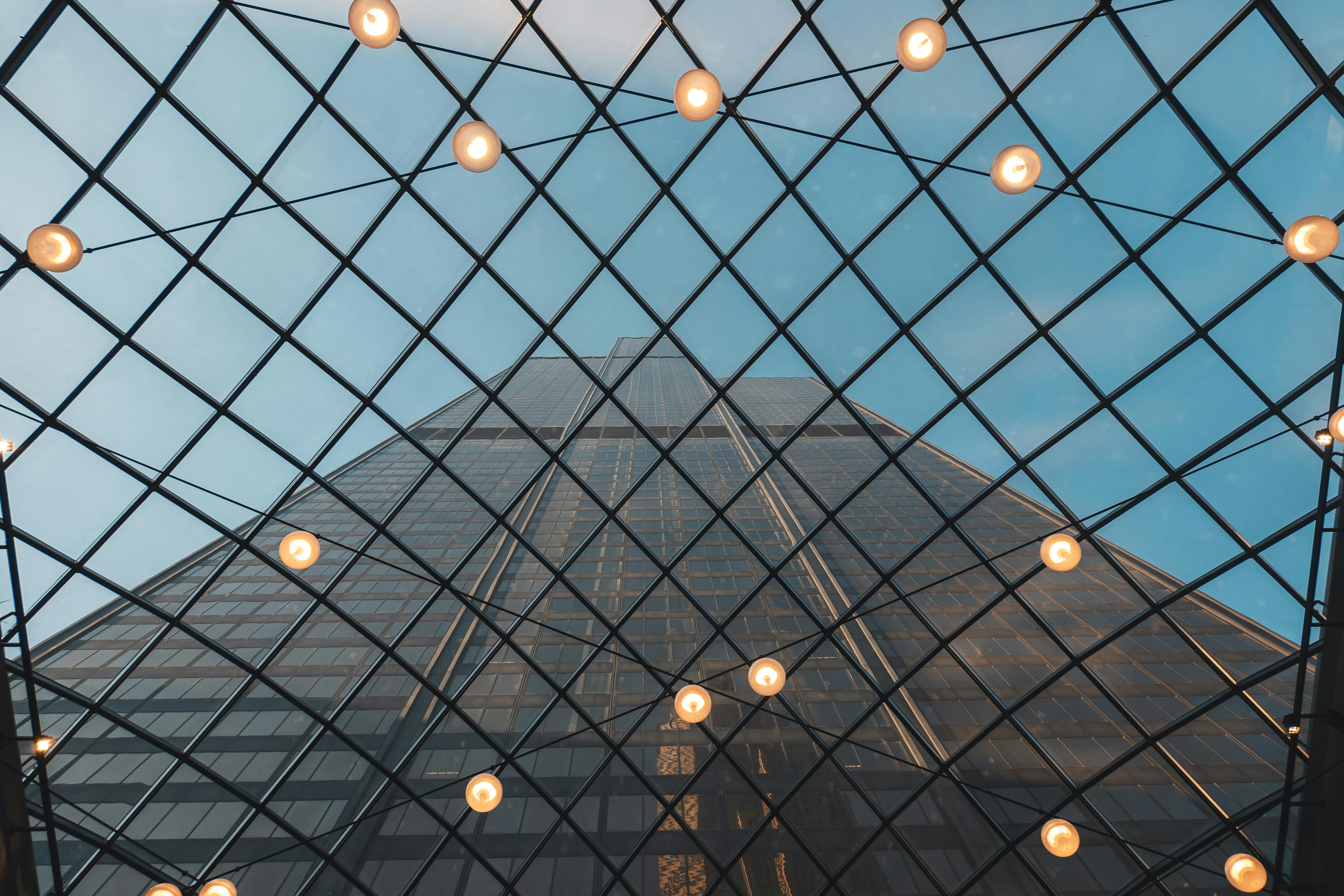 Modern Skyscraper Through Geometric Grid with Lights · Free Stock Photo