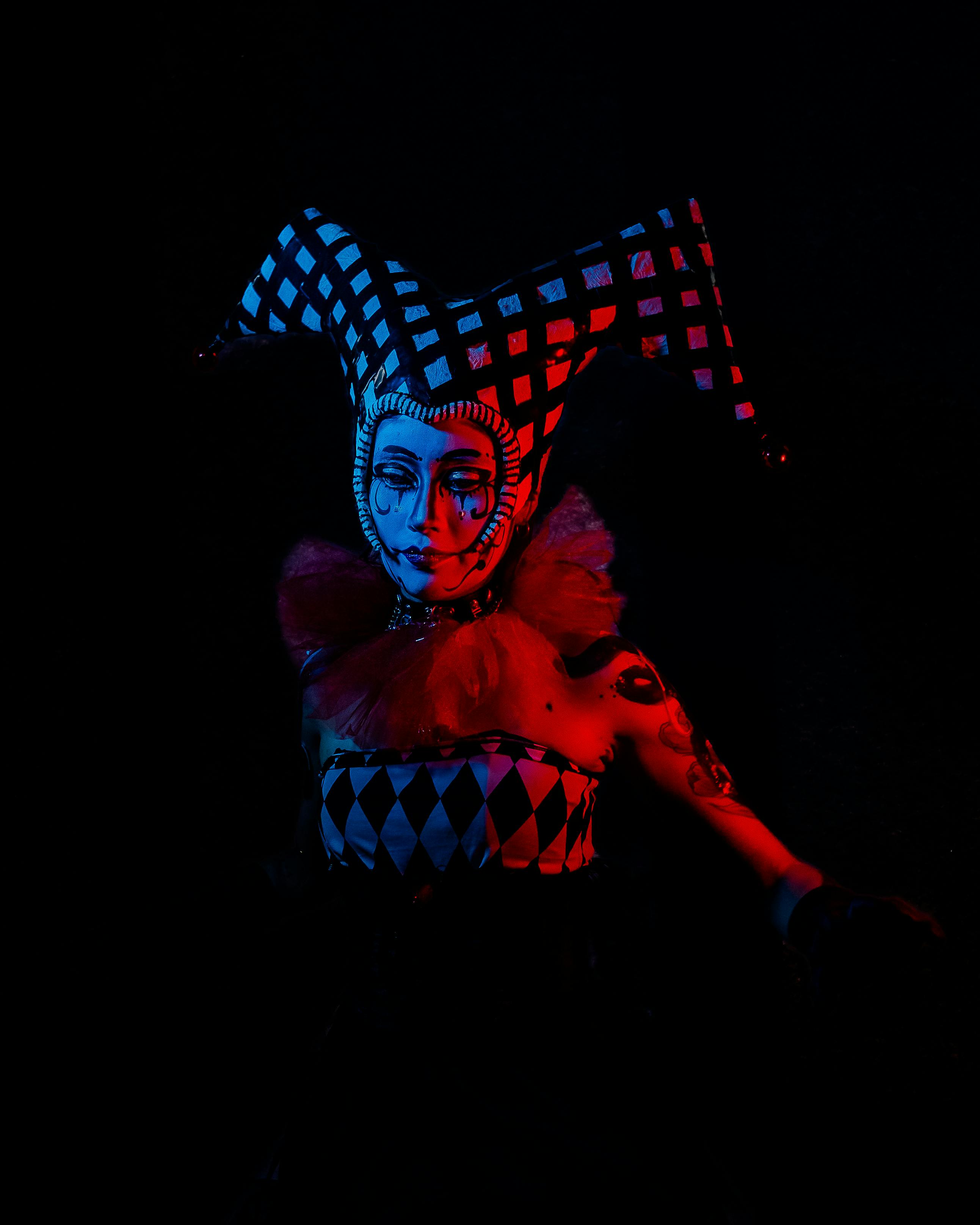 Surreal Jester Costume in Dramatic Lighting · Free Stock Photo