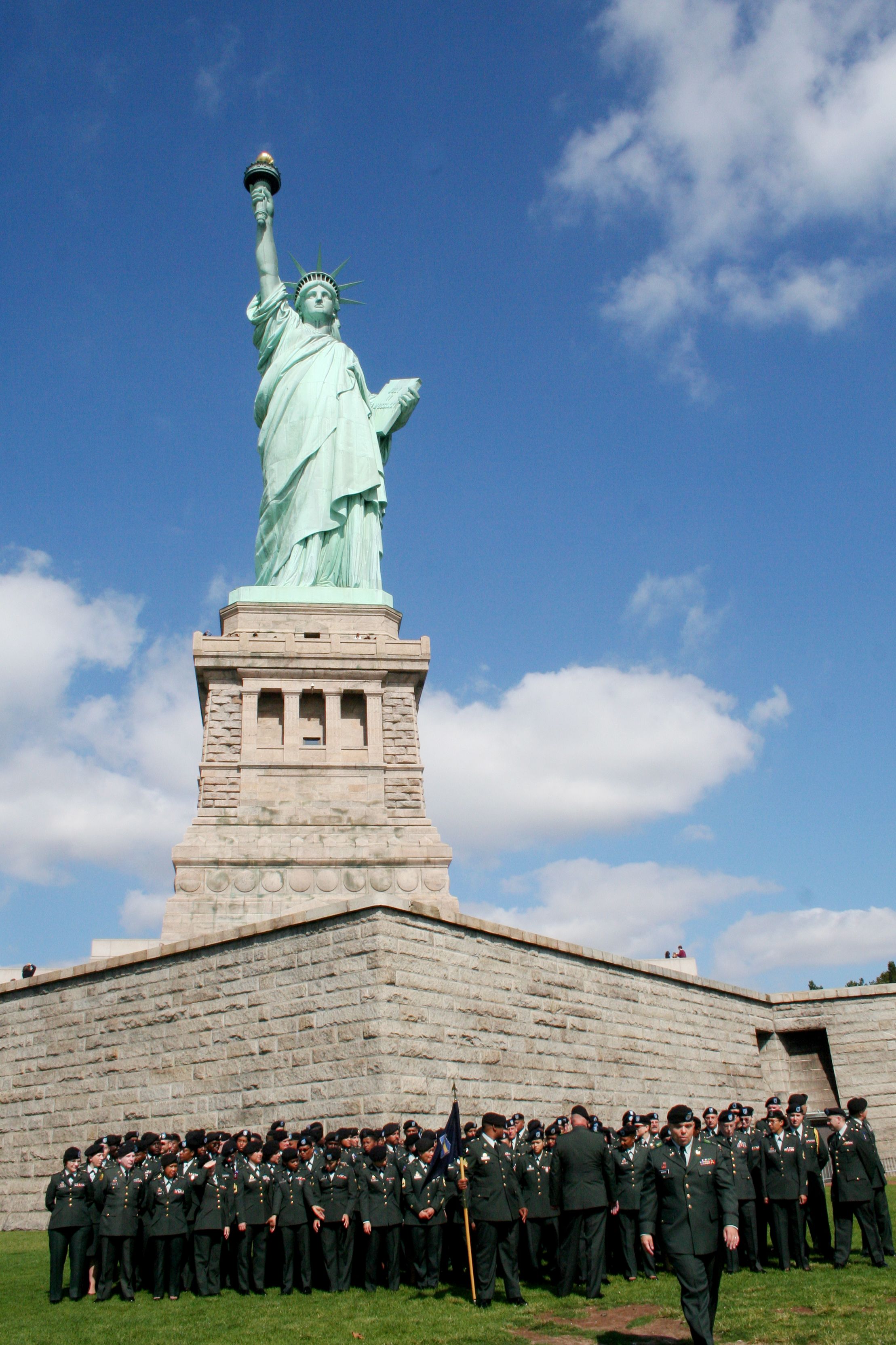Statue of Liberty with Crowd Gathering Below · Free Stock Photo