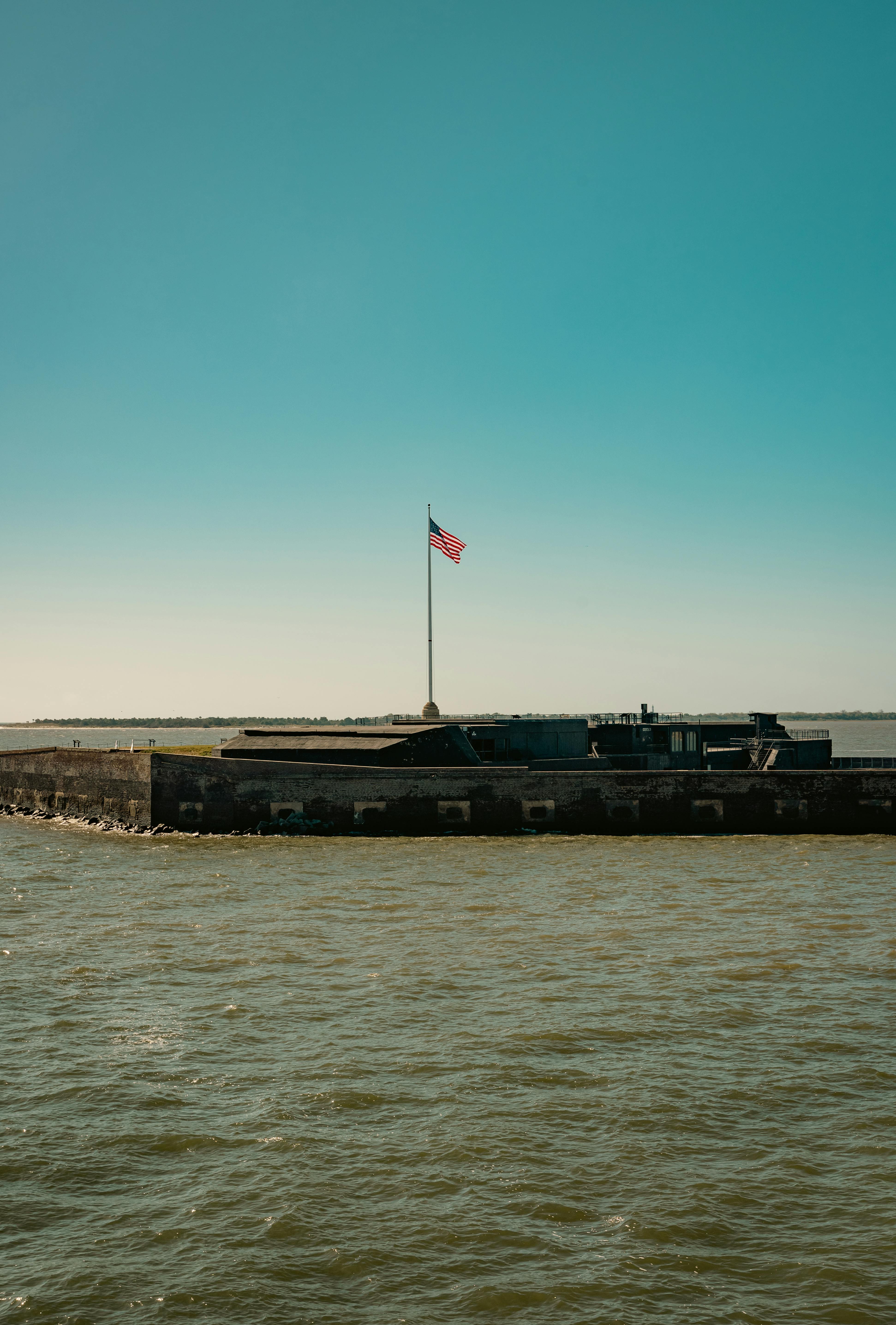 Historic Fort with American Flag Overlooking the Sea · Free Stock Photo