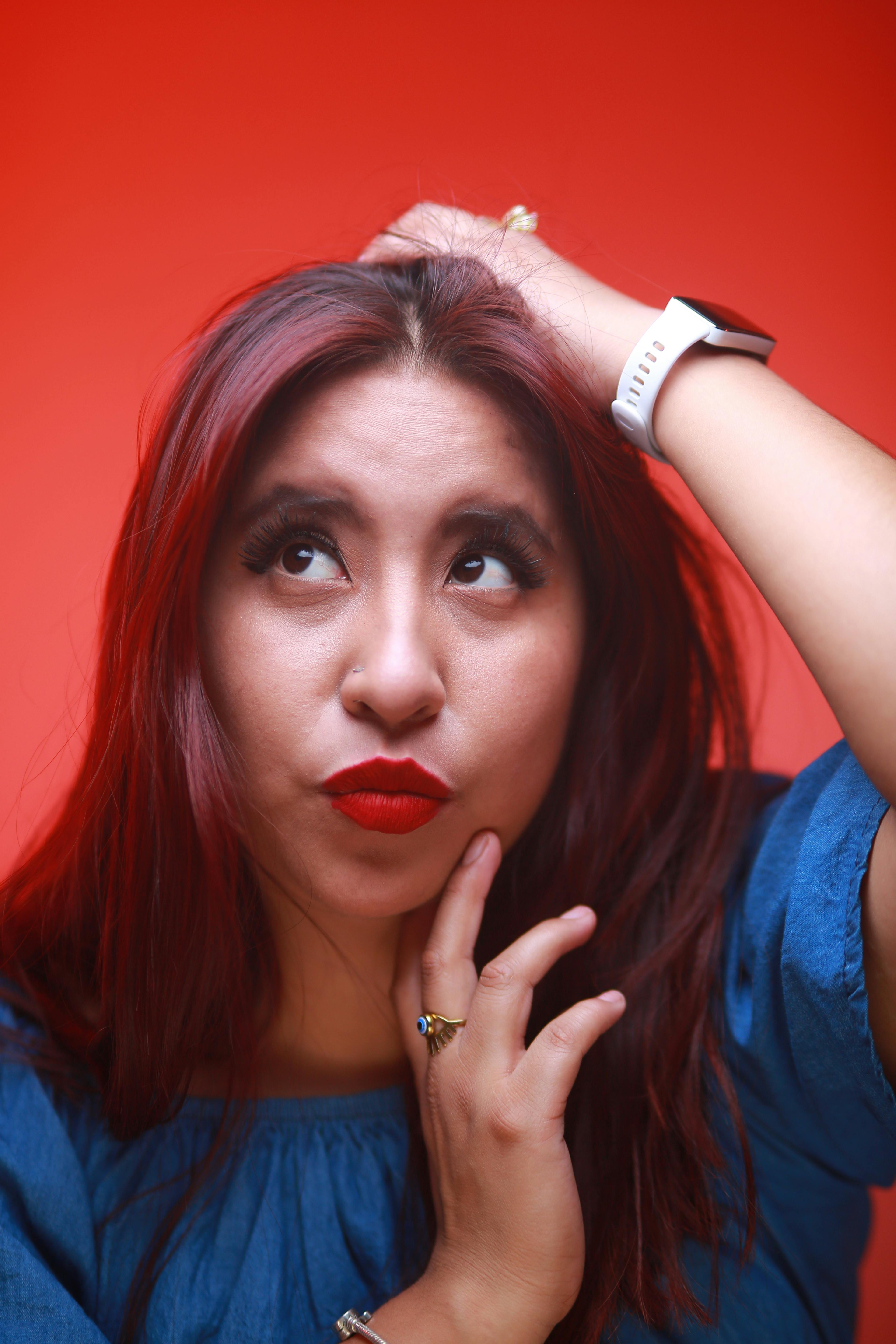 Portrait of a Woman with Red Background · Free Stock Photo