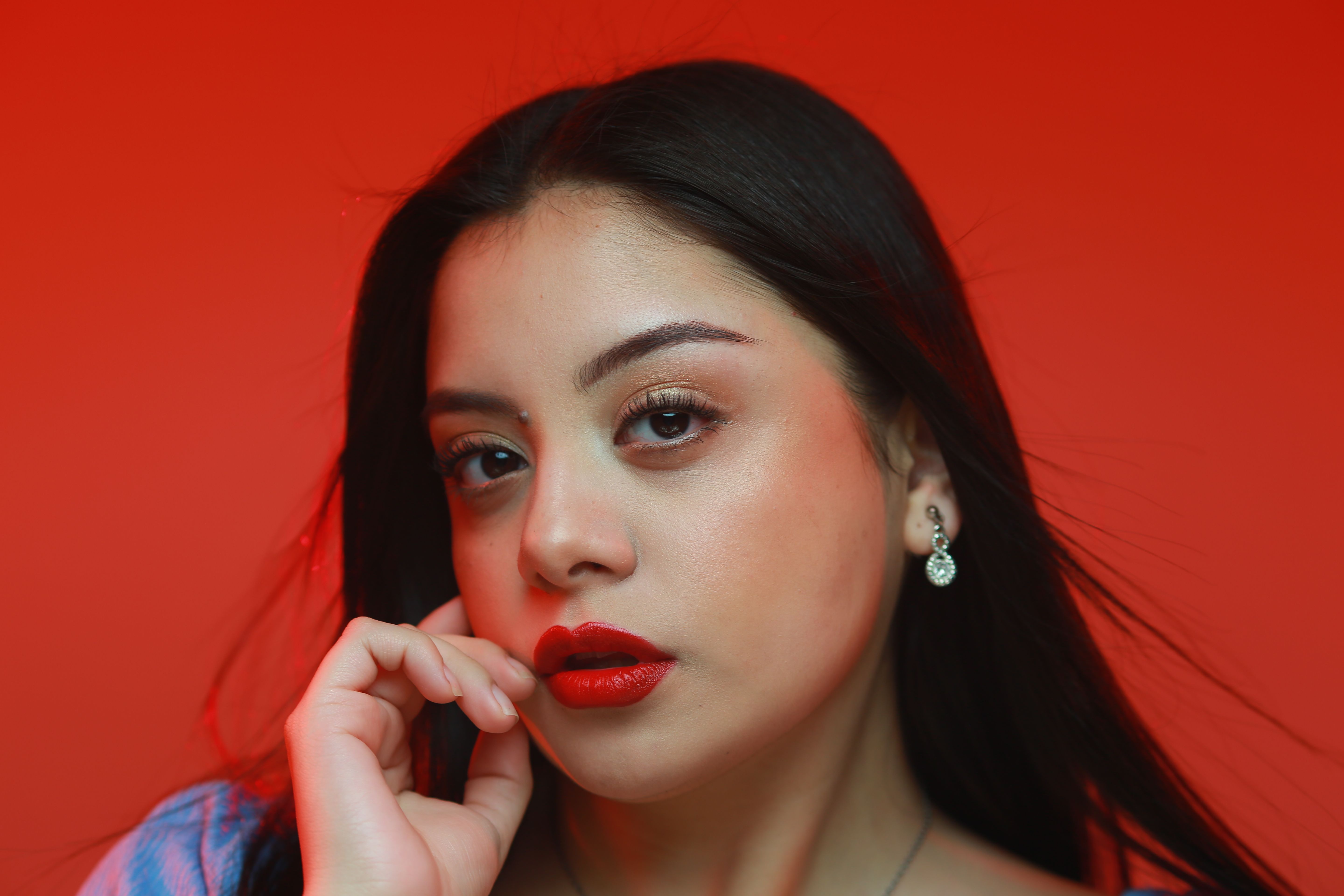 Elegant Portrait of Woman with Red Background · Free Stock Photo