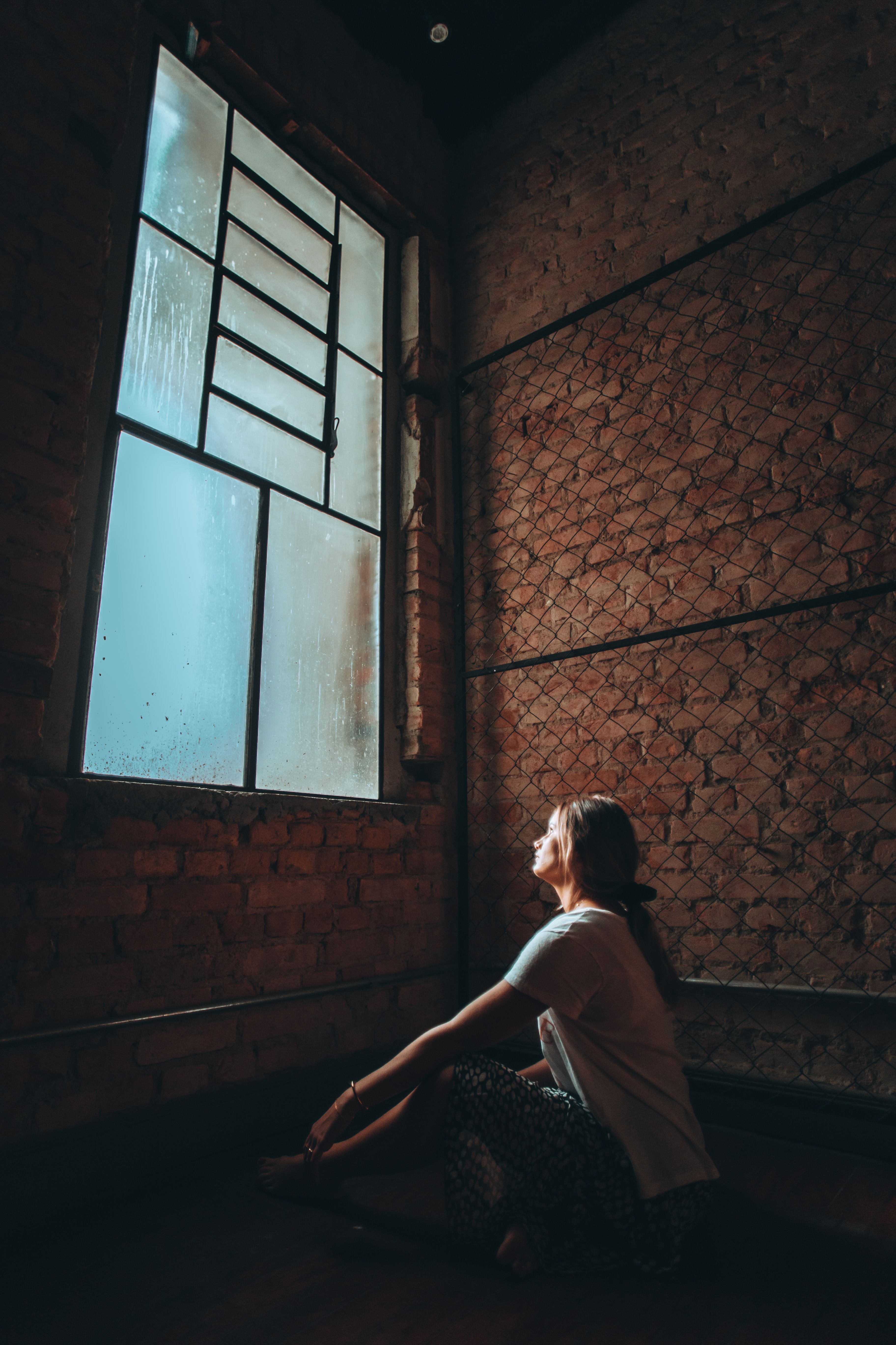 Photo Of Woman Sits Near The Window · Free Stock Photo