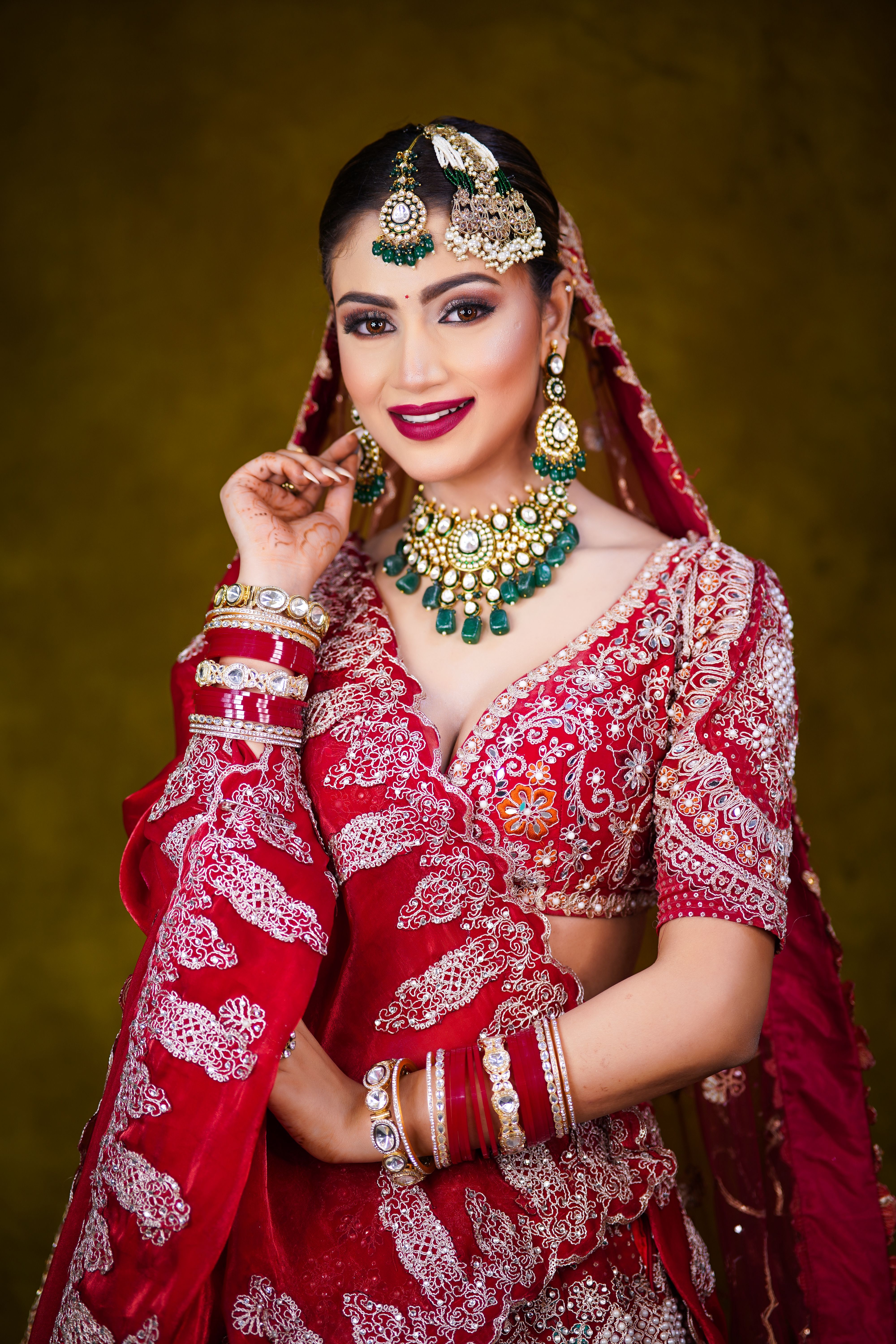 Elegant Bride in Traditional Red Attire with Jewelry · Free Stock Photo