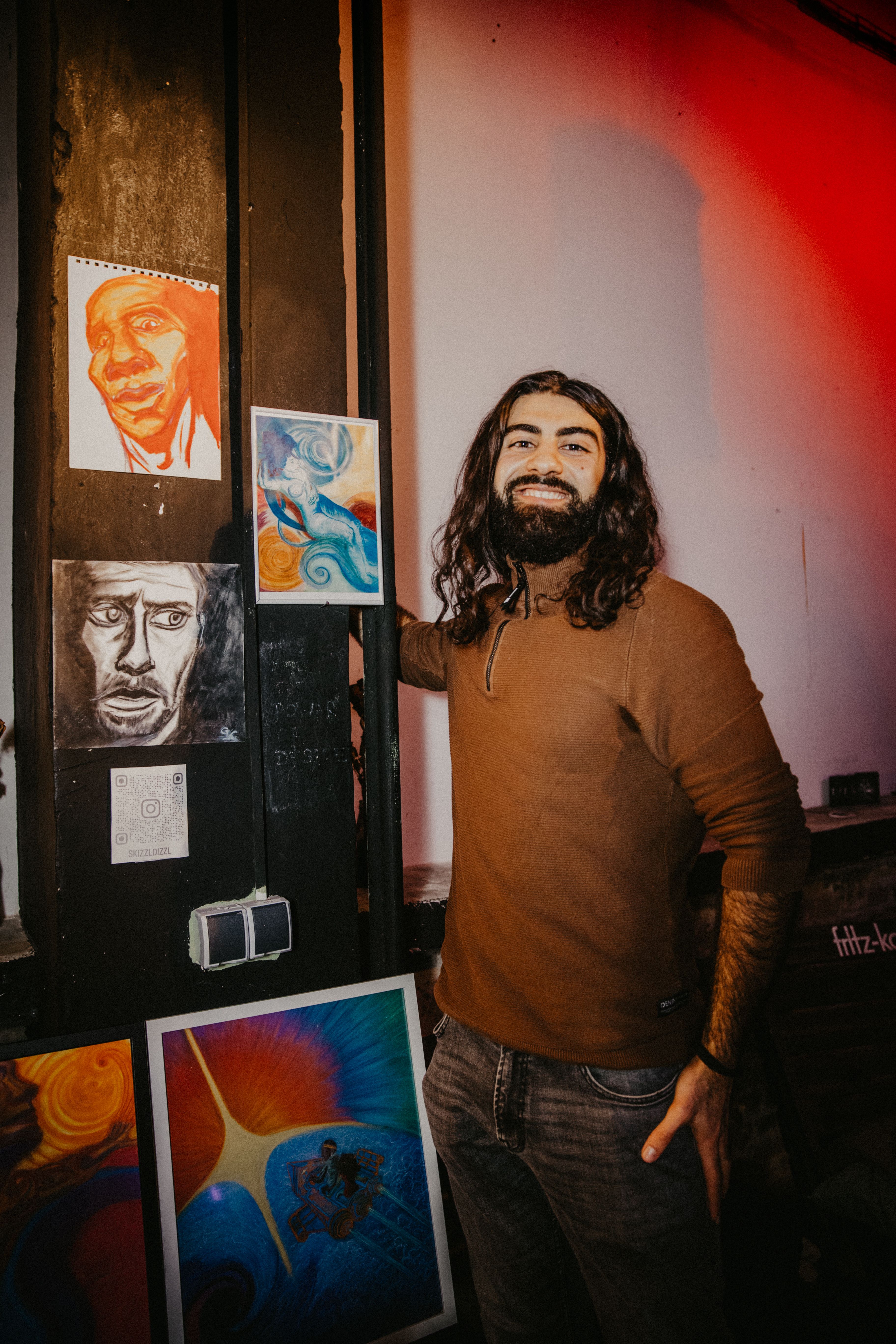 Artist Showcasing Vibrant Portraits in Berlin Gallery · Free Stock Photo
