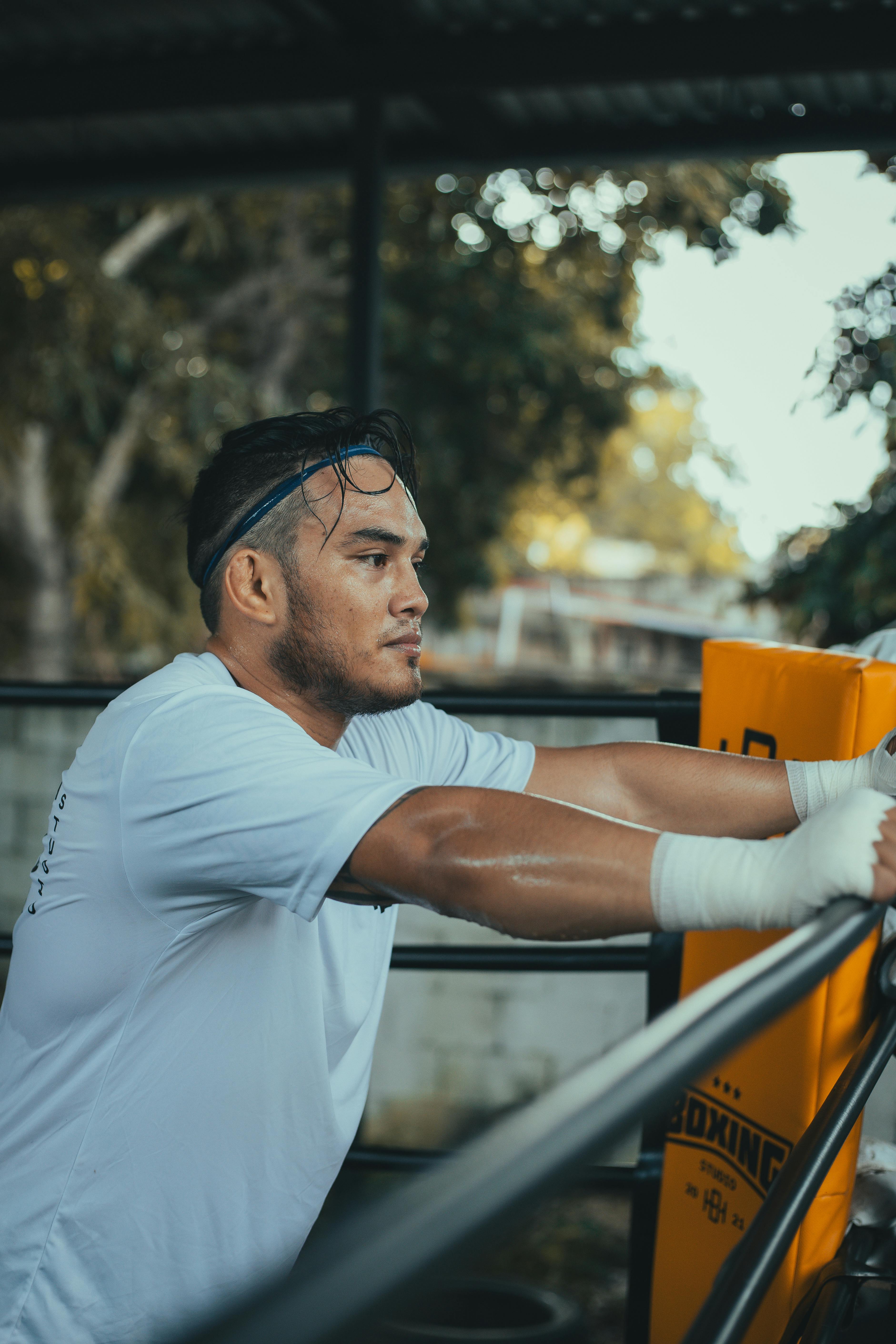 Focused Boxer Resting in Outdoor Ring · Free Stock Photo