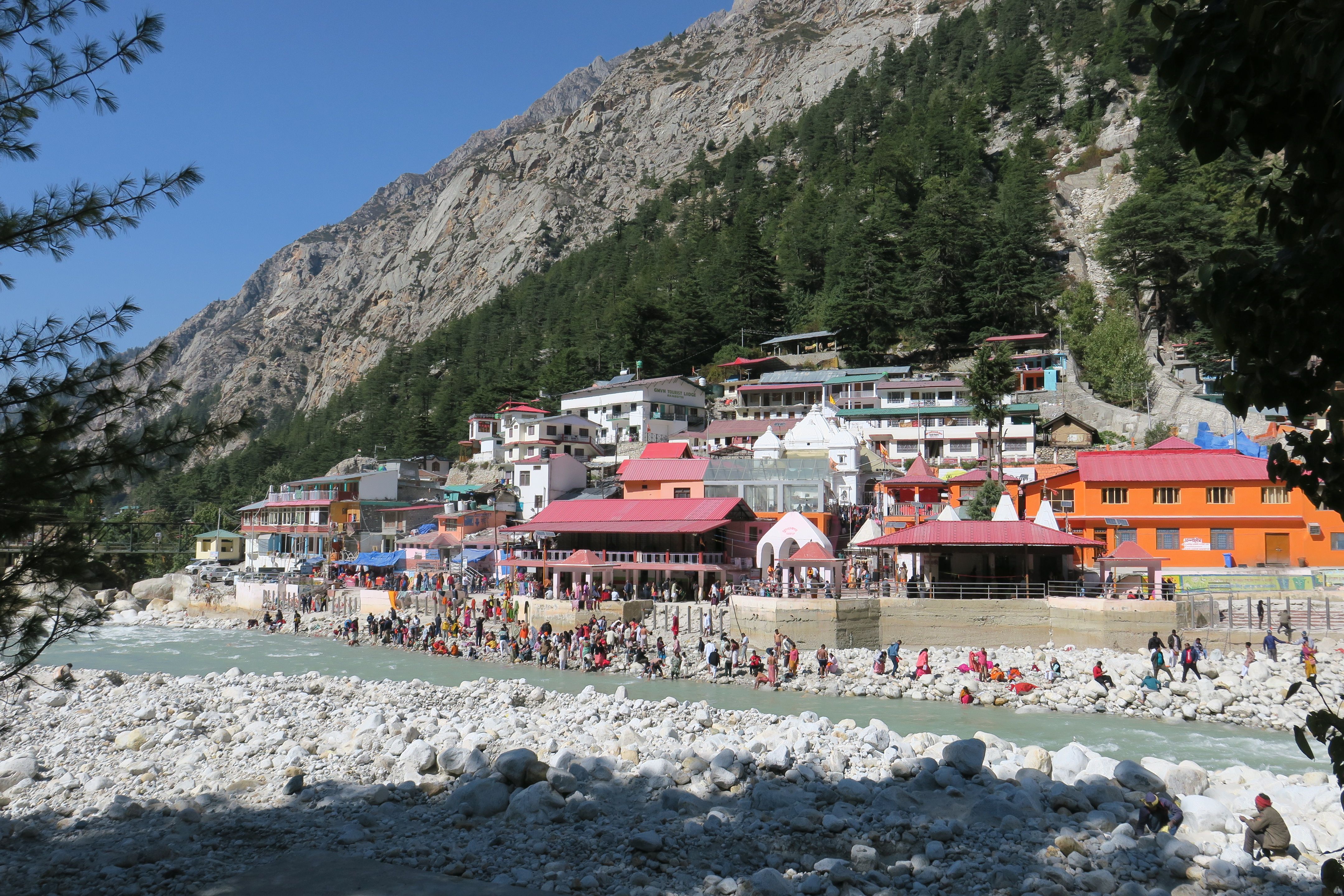 Crowd Gathered by the Riverside in Mountain Village · Free Stock Photo