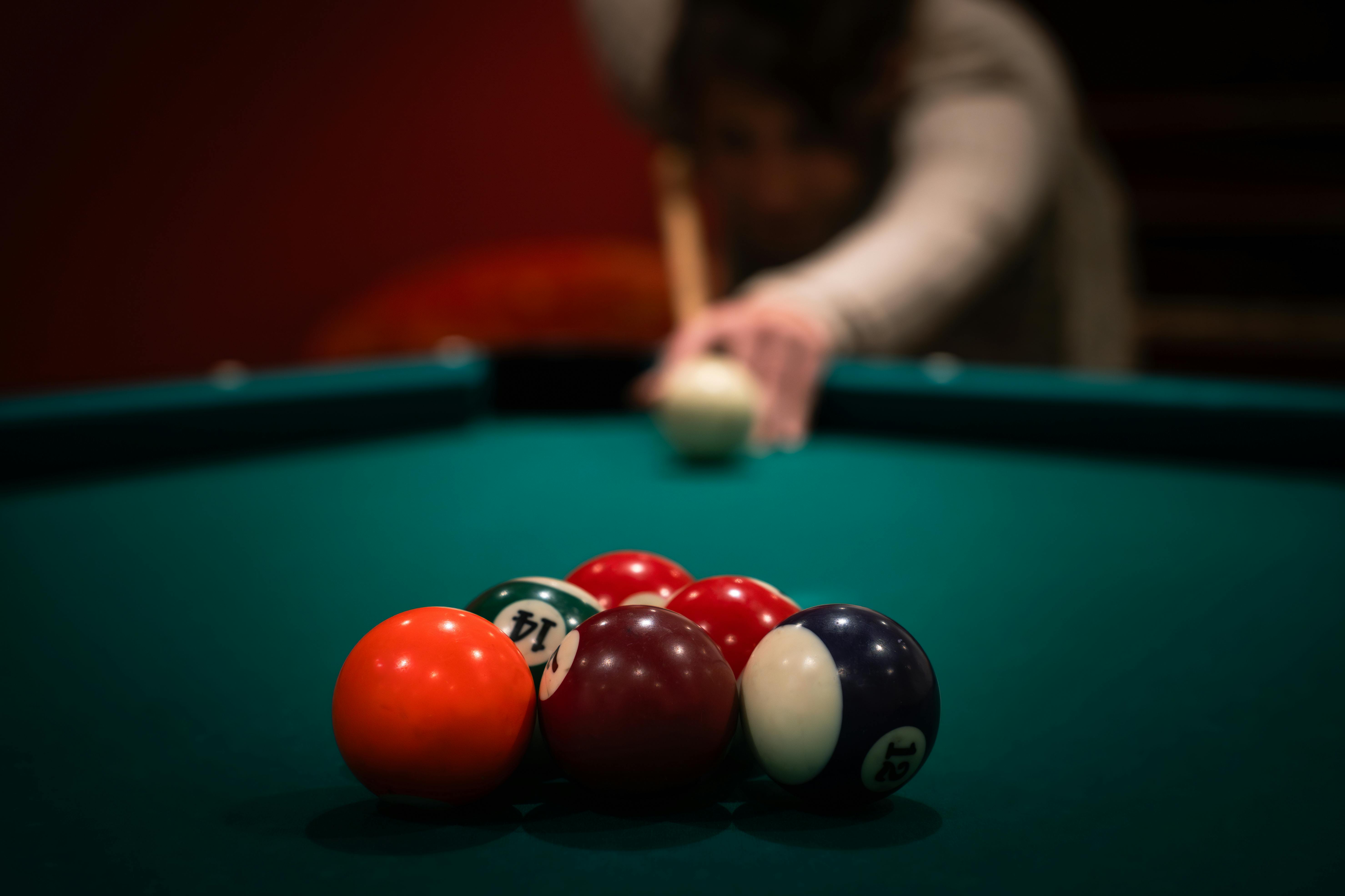 Billiards Player Aiming at Pool Table Balls · Free Stock Photo