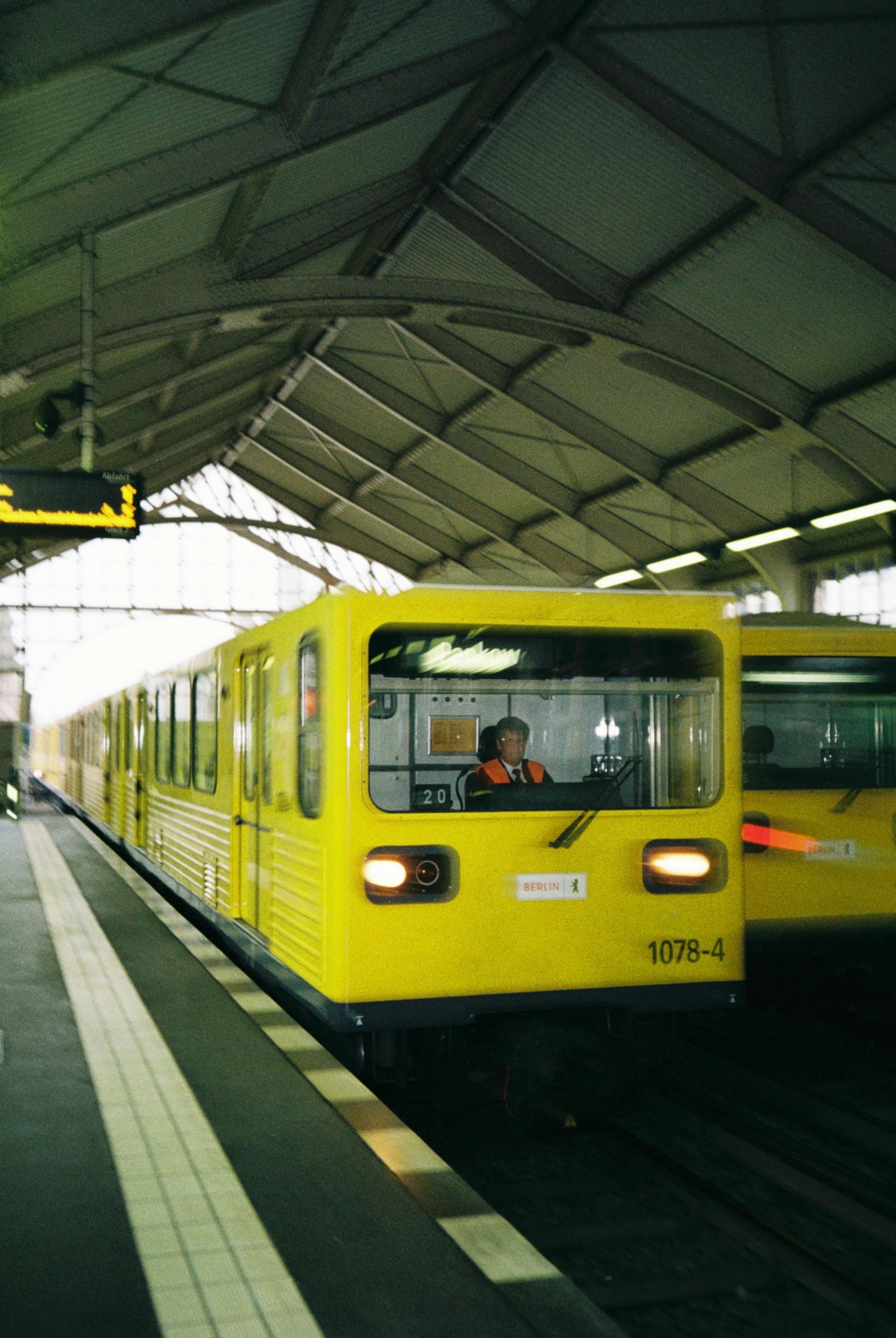 Yellow Train in Urban European Station · Free Stock Photo