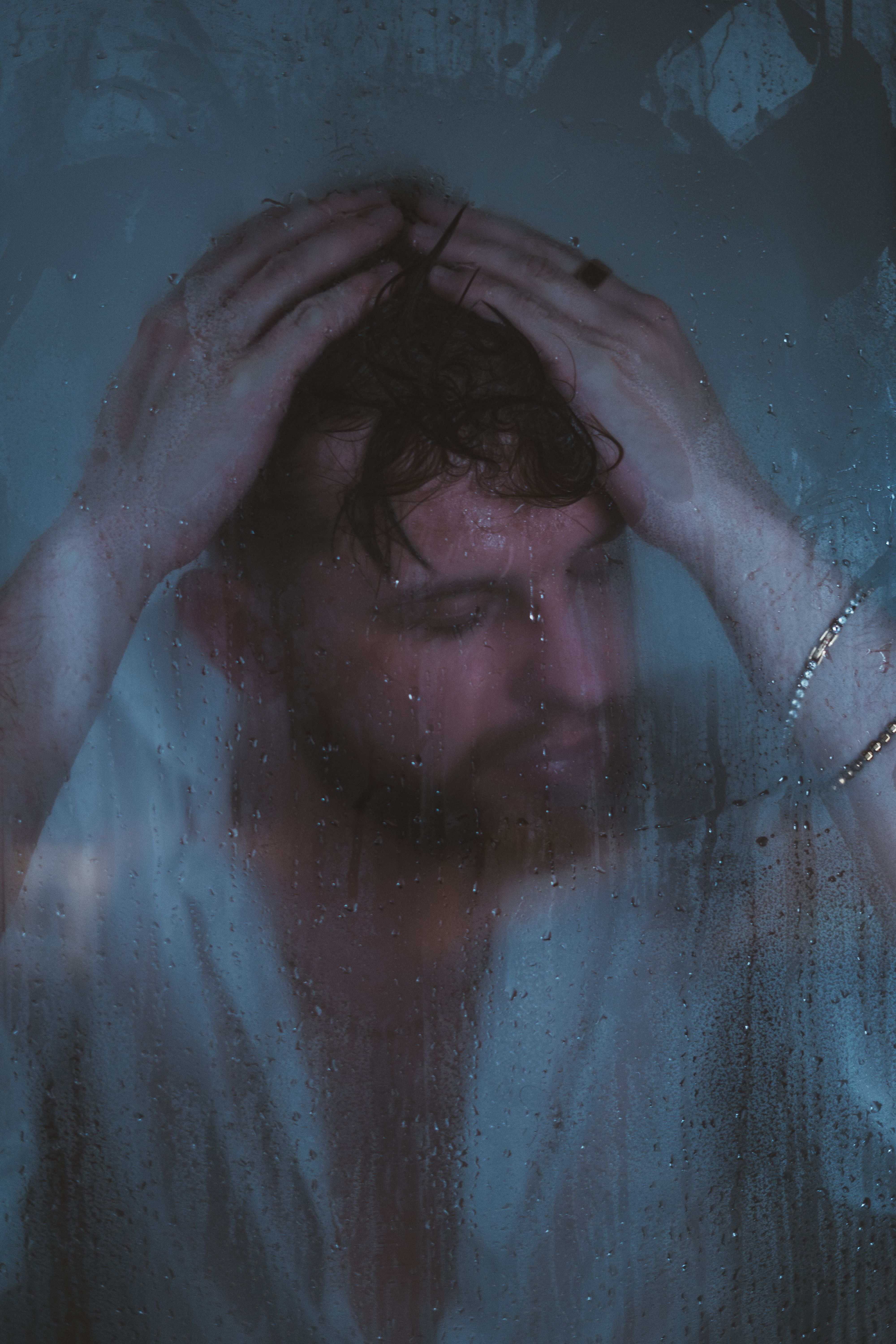 Moody Portrait of Man Behind Wet Glass · Free Stock Photo