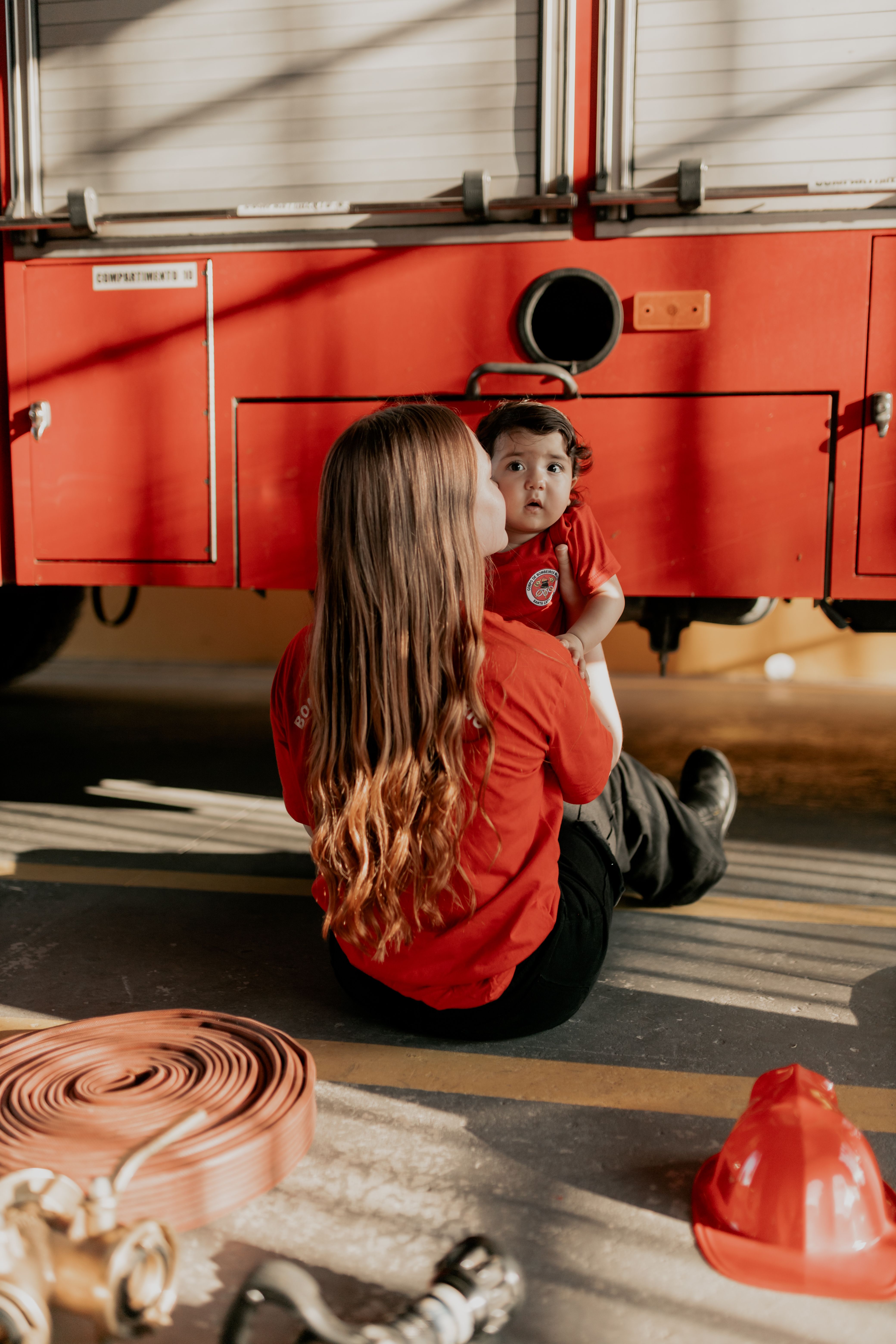 Firefighter with Child at Fire Station · Free Stock Photo