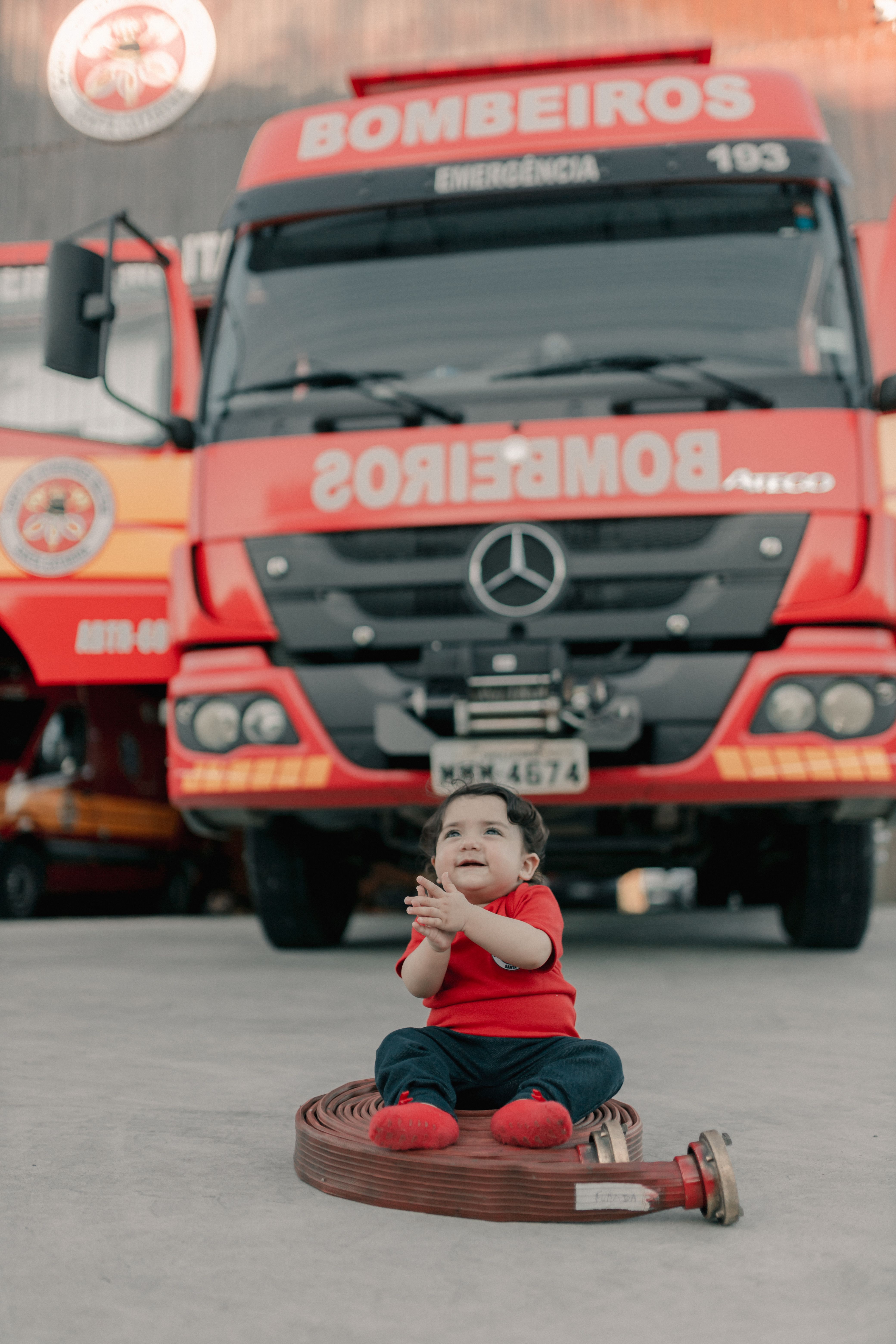 Child Playing Near Fire Truck at Fire Station · Free Stock Photo