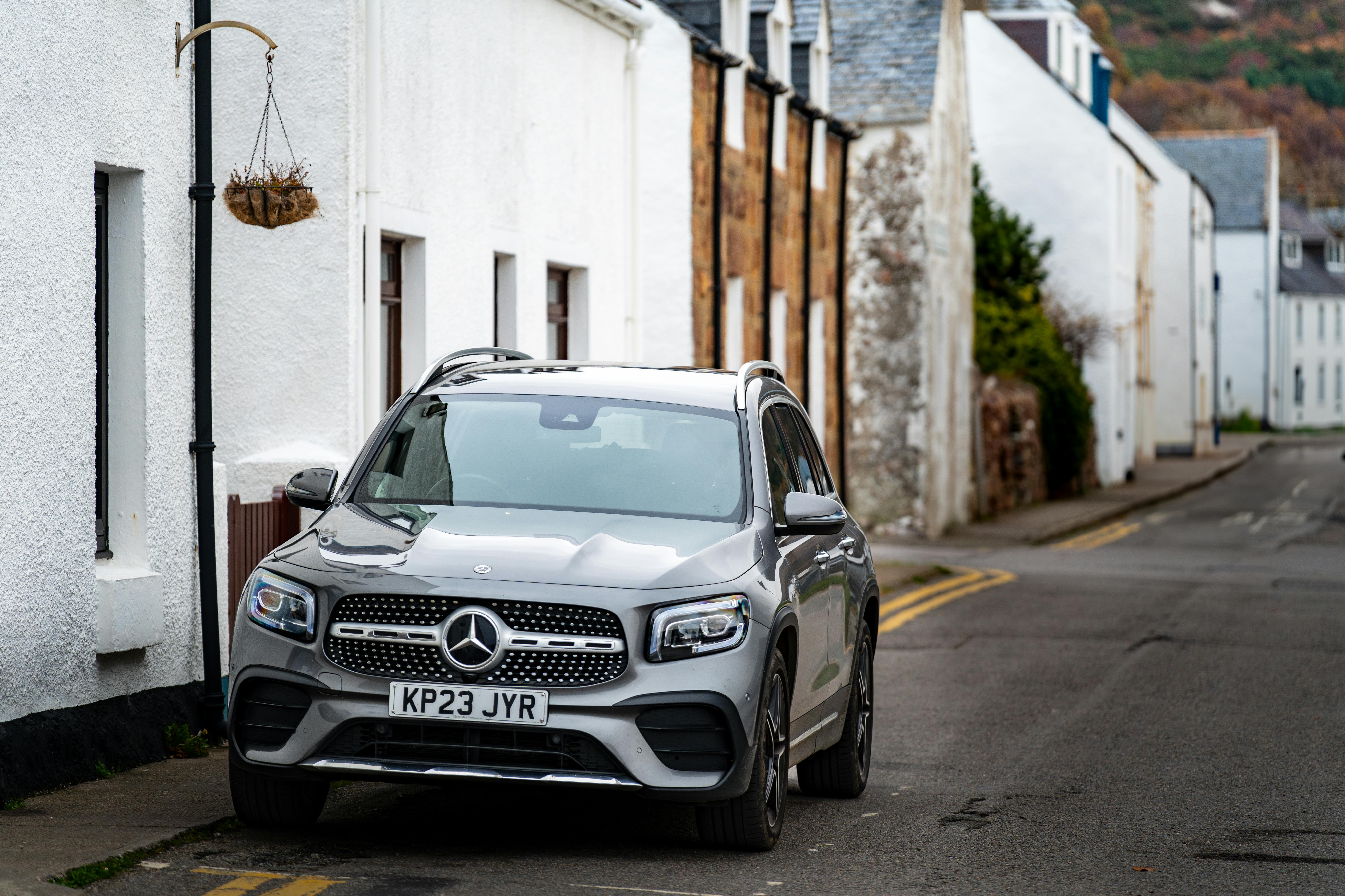 Luxury Car Parked on Quaint Village Street · Free Stock Photo