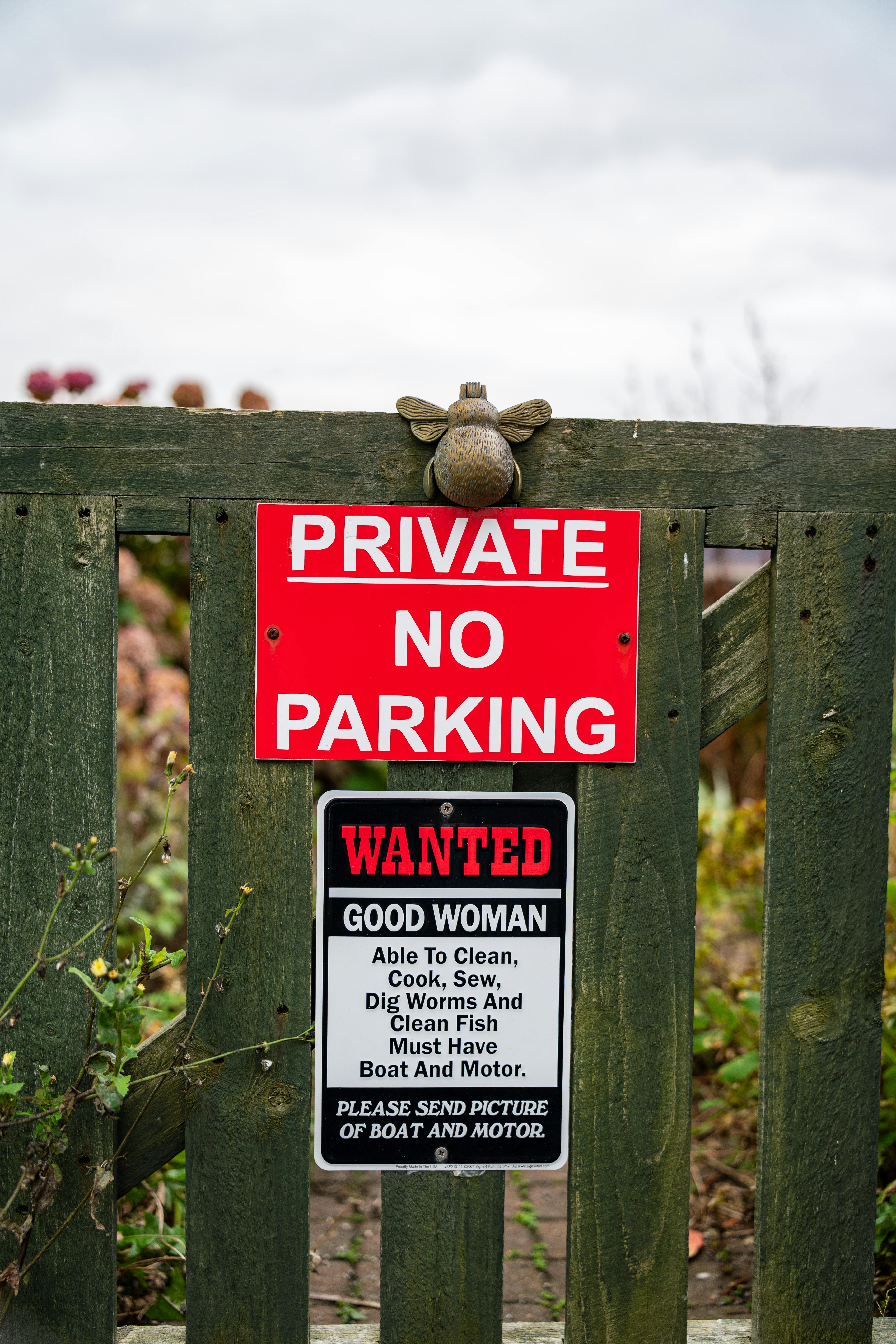 Humorous Private No Parking Sign on Wooden Fence · Free Stock Photo