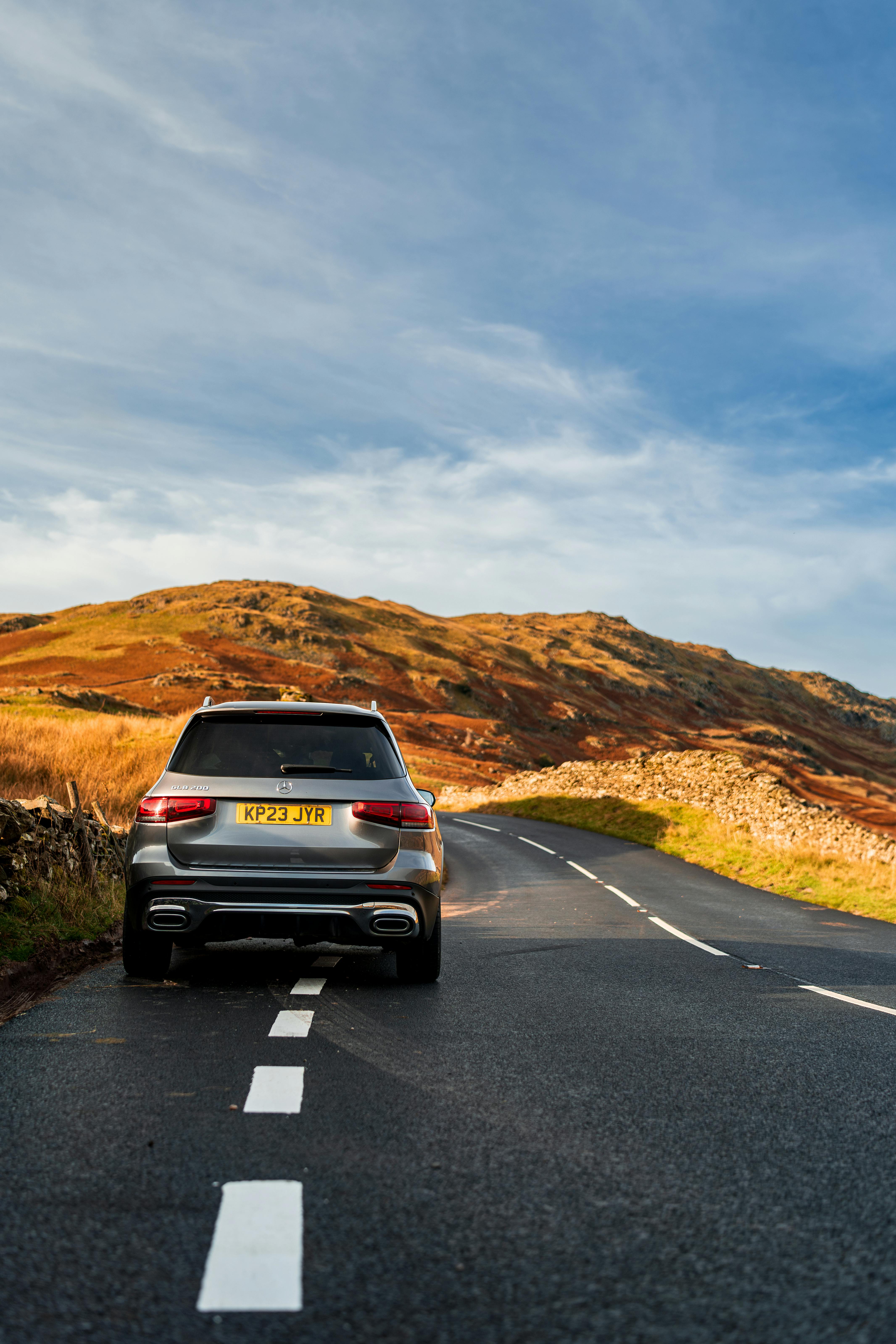 Red Car Travels on the Curved Road · Free Stock Photo
