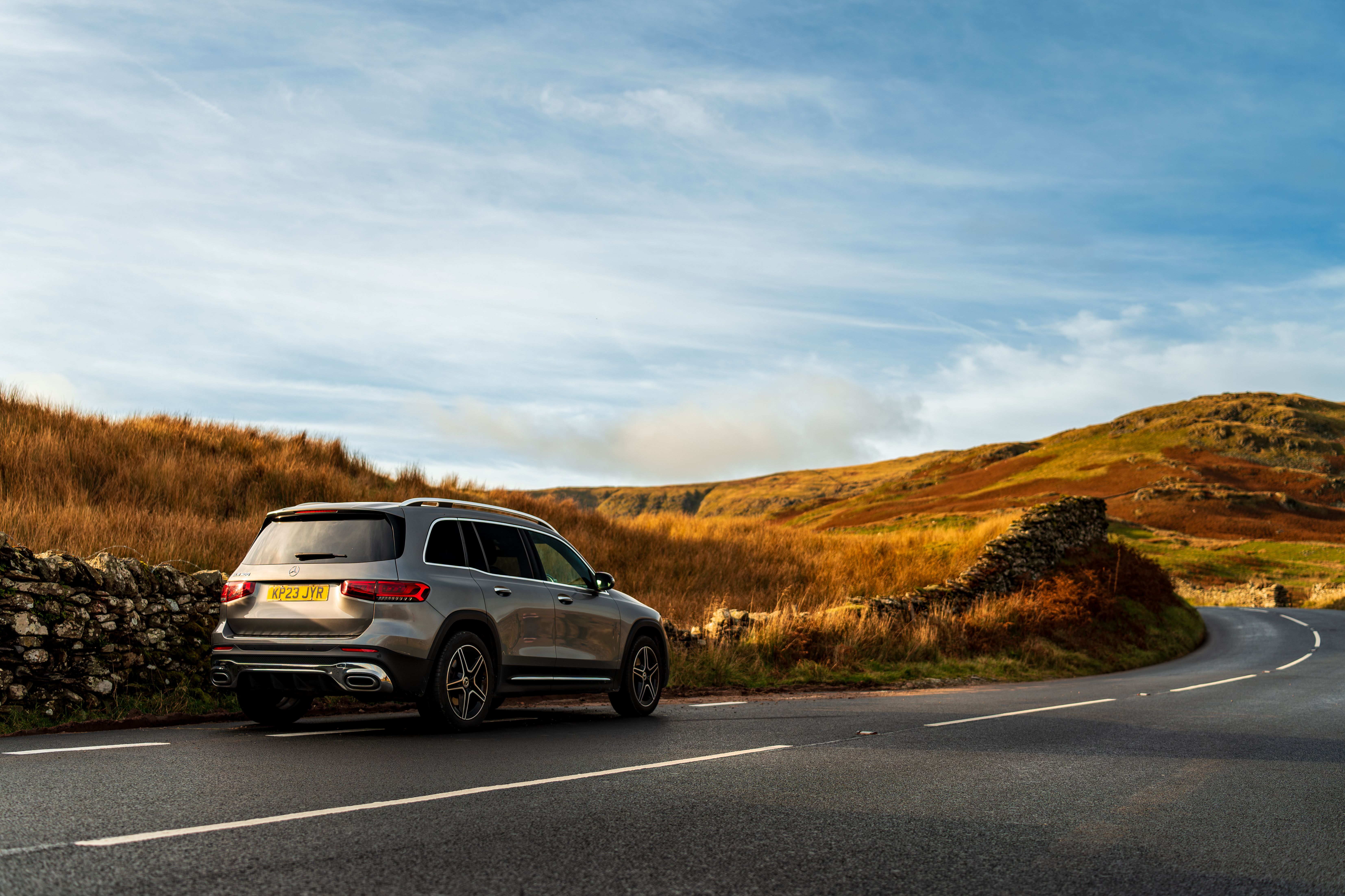 SUV Driving on Scenic Countryside Road · Free Stock Photo