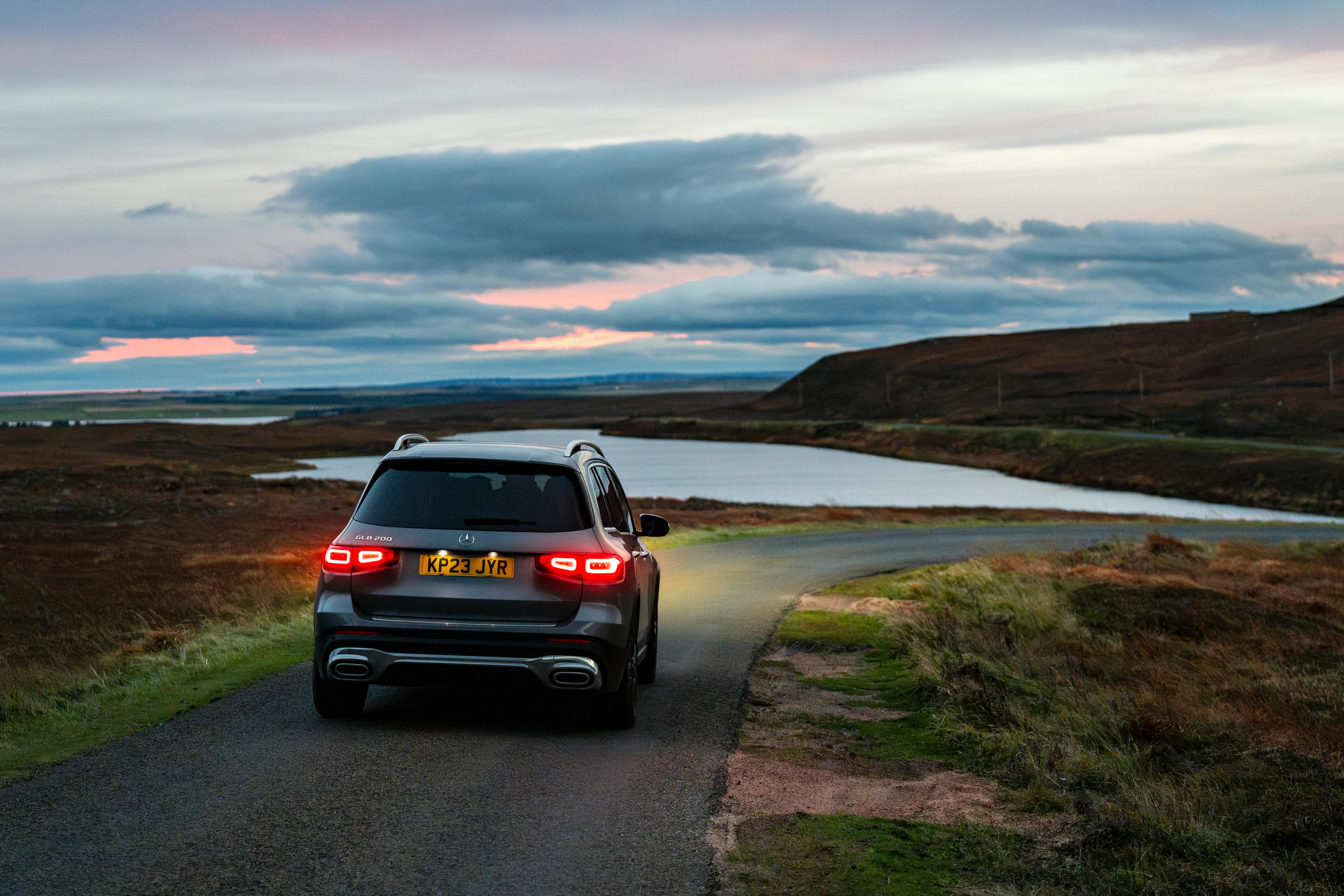 Scenic Road Trip at Twilight with SUV · Free Stock Photo