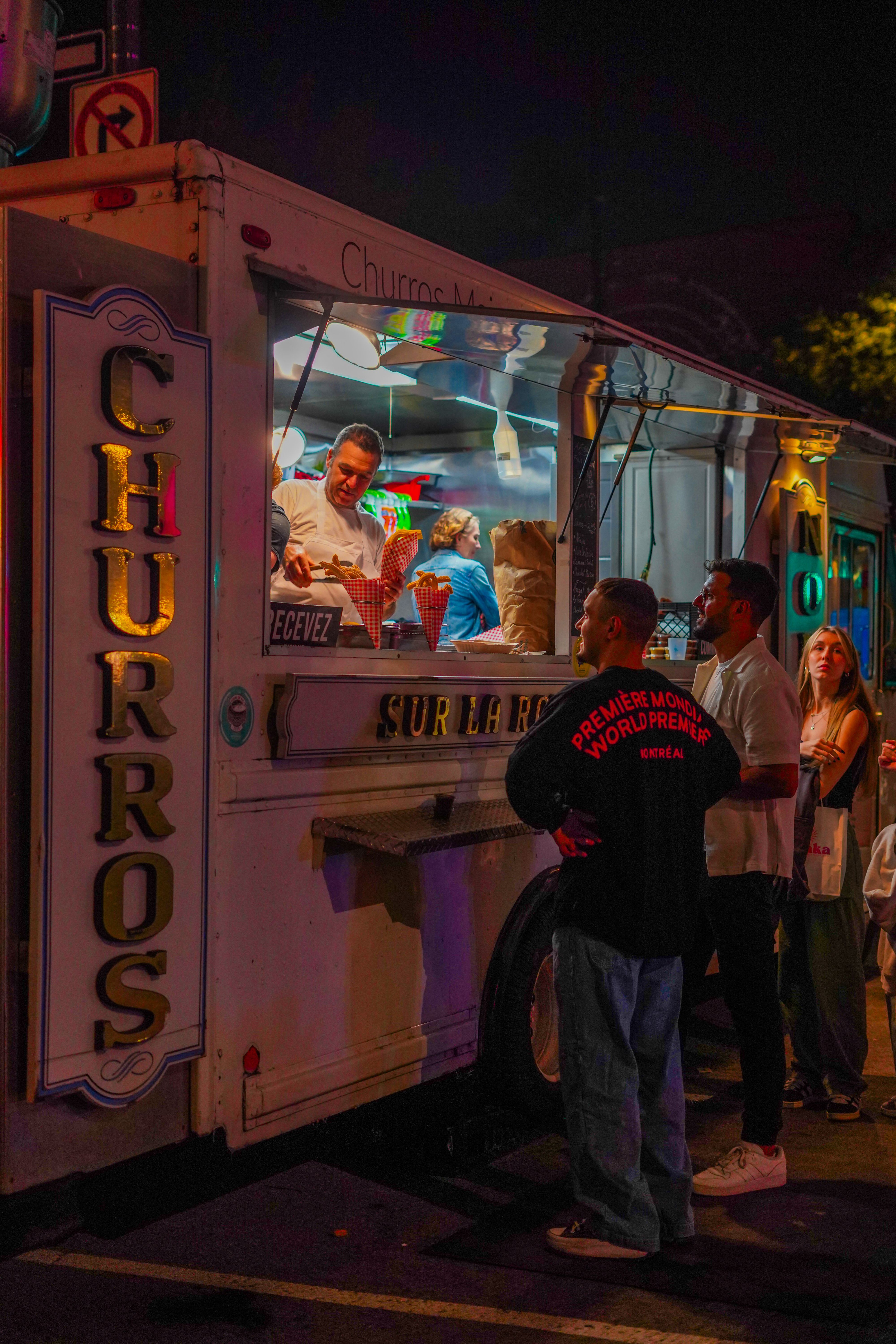 Night Street Food Vendors Selling Churros · Free Stock Photo