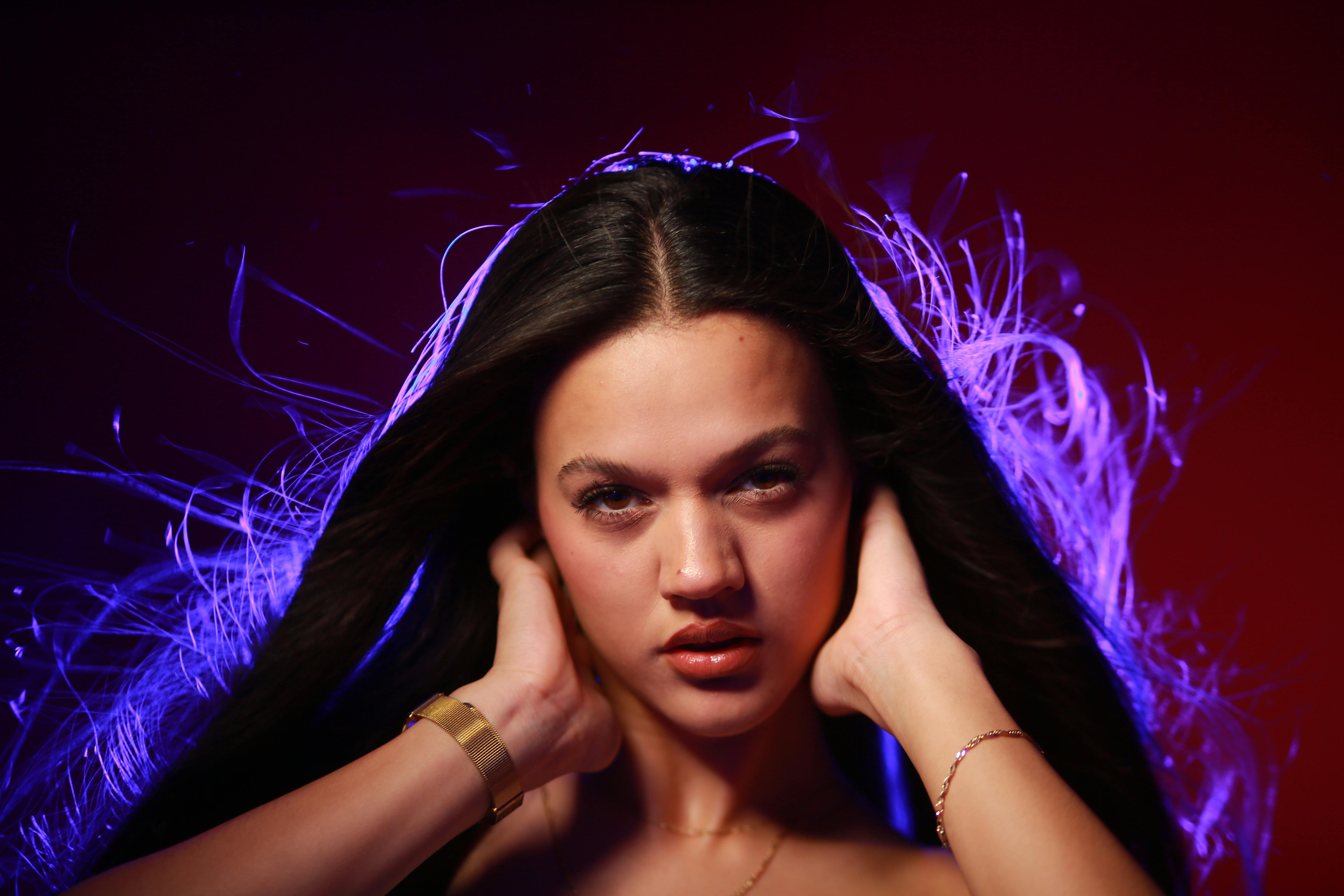 Striking Portrait of Woman with Vibrant Hair Lighting · Free Stock Photo