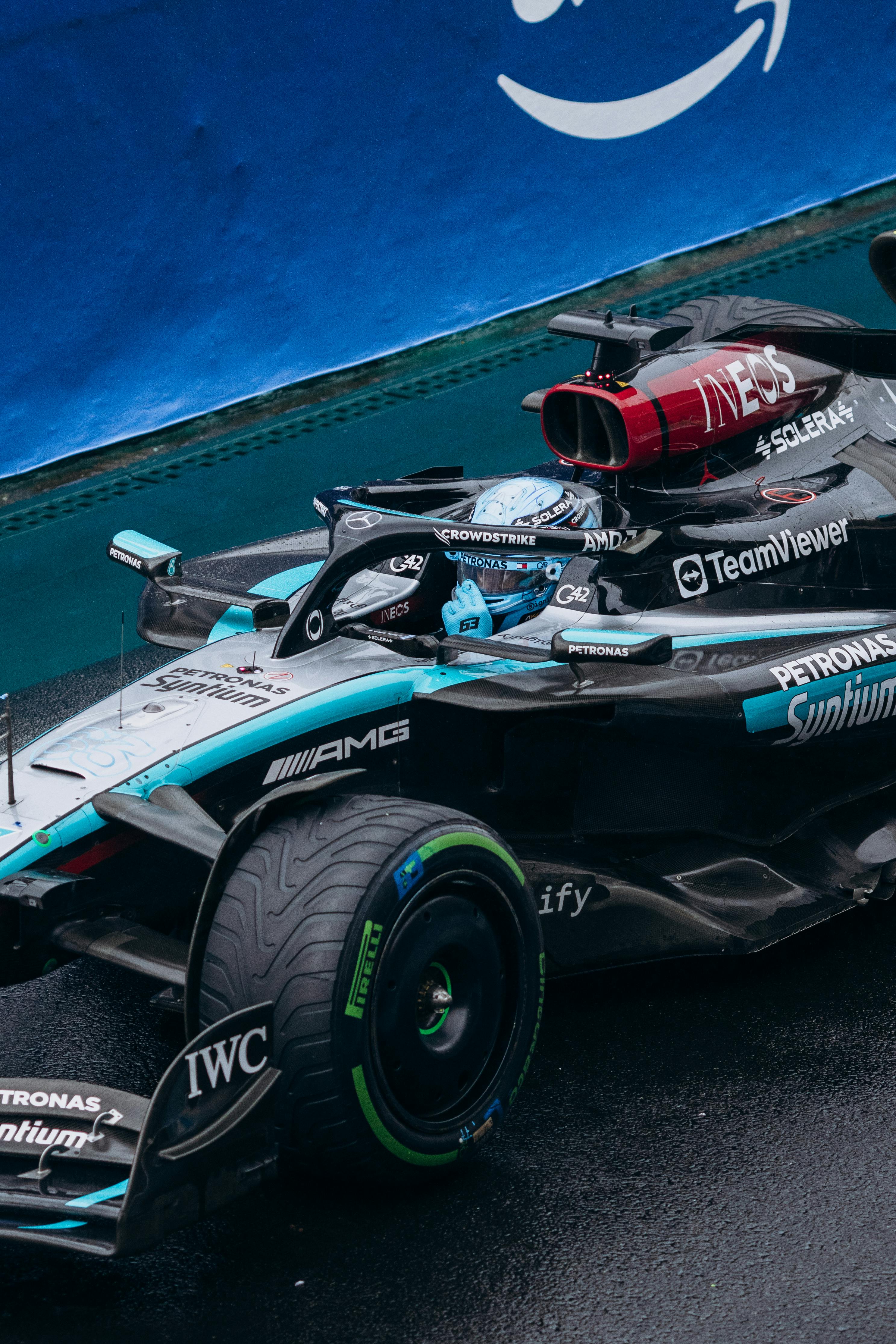 Formula 1 Race Car Taking a Sharp Turn · Free Stock Photo
