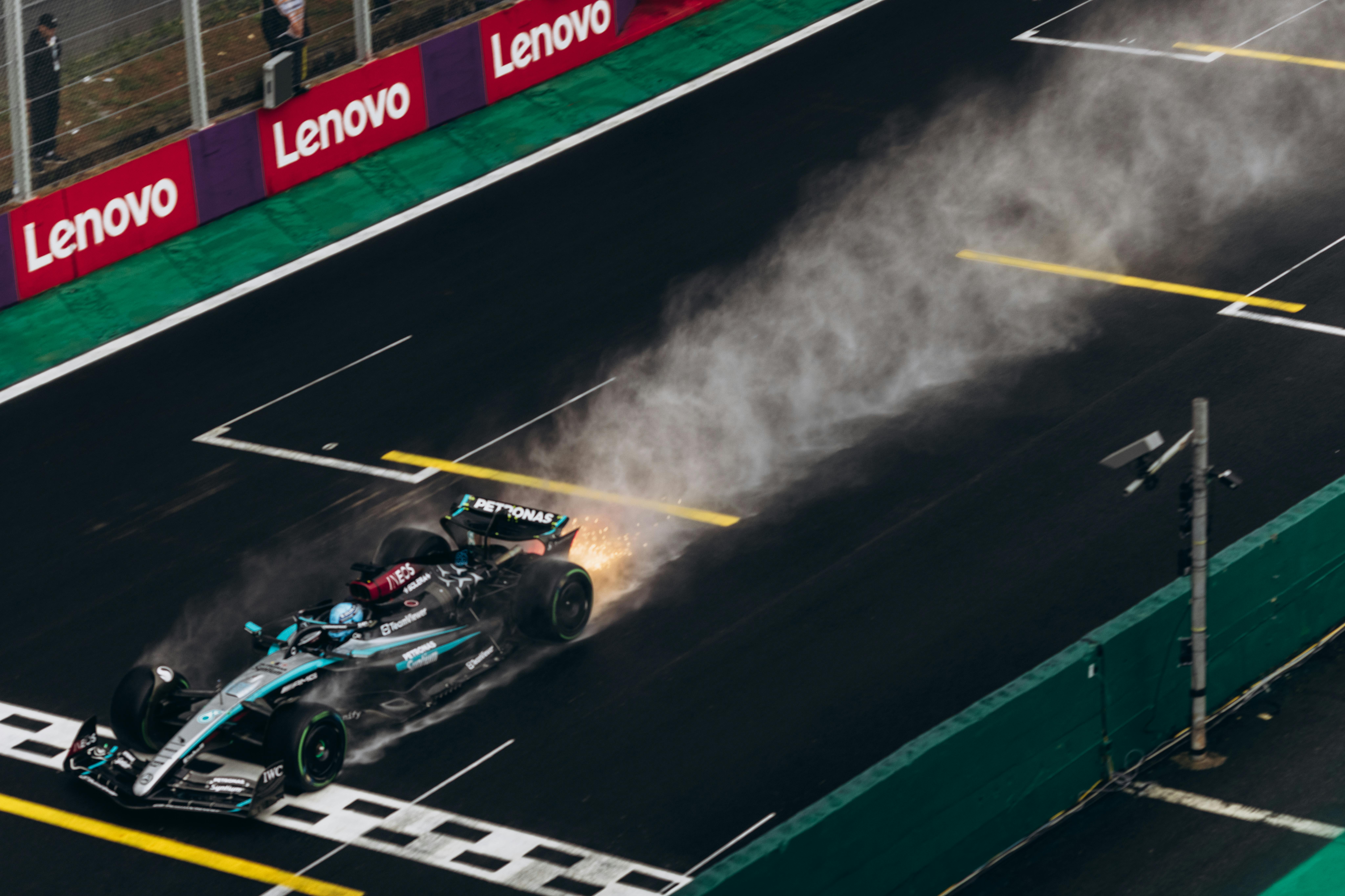 High-Speed Formula Racing on Wet Track · Free Stock Photo