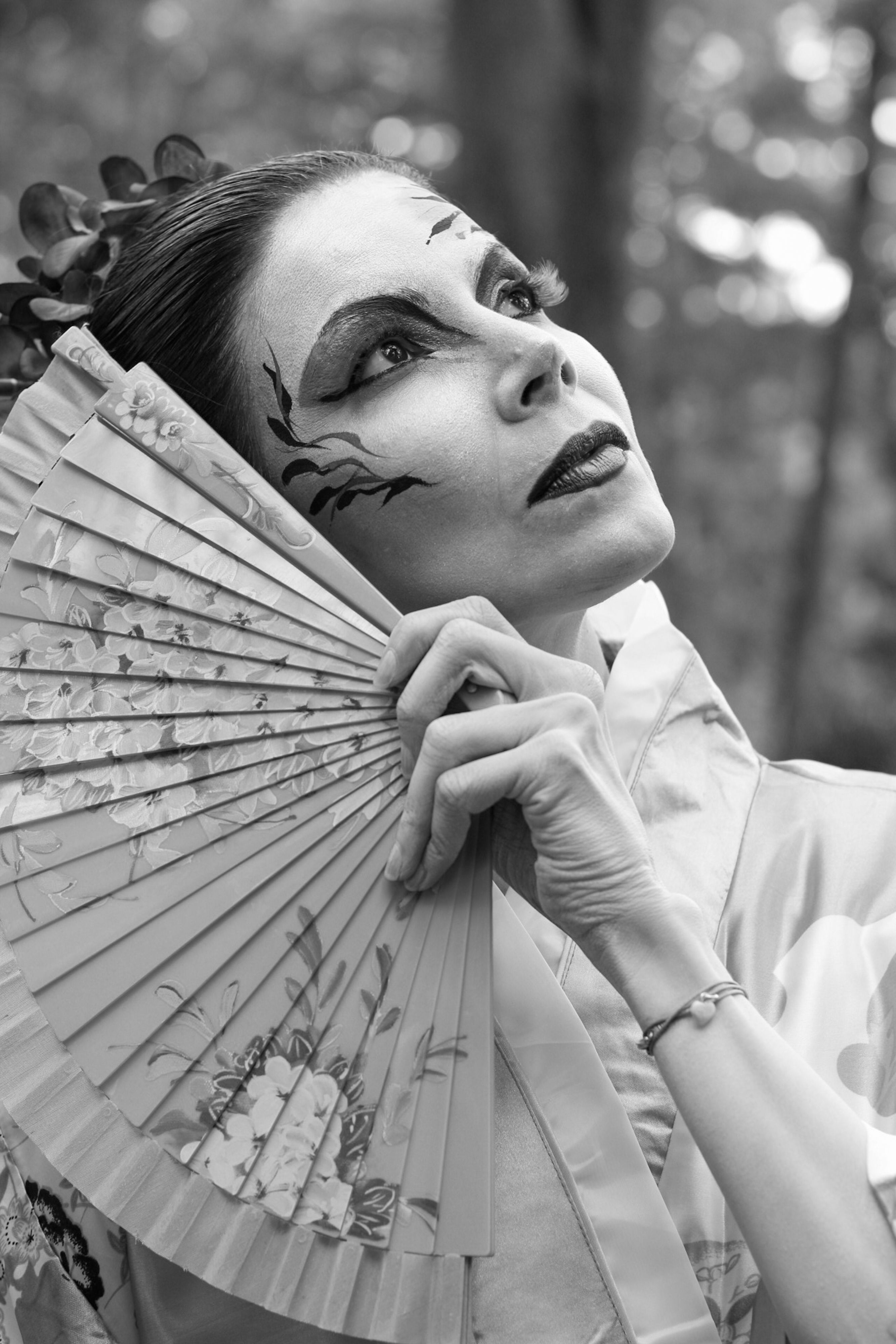 Artistic Portrait of Woman with Fan and Face Paint · Free Stock Photo