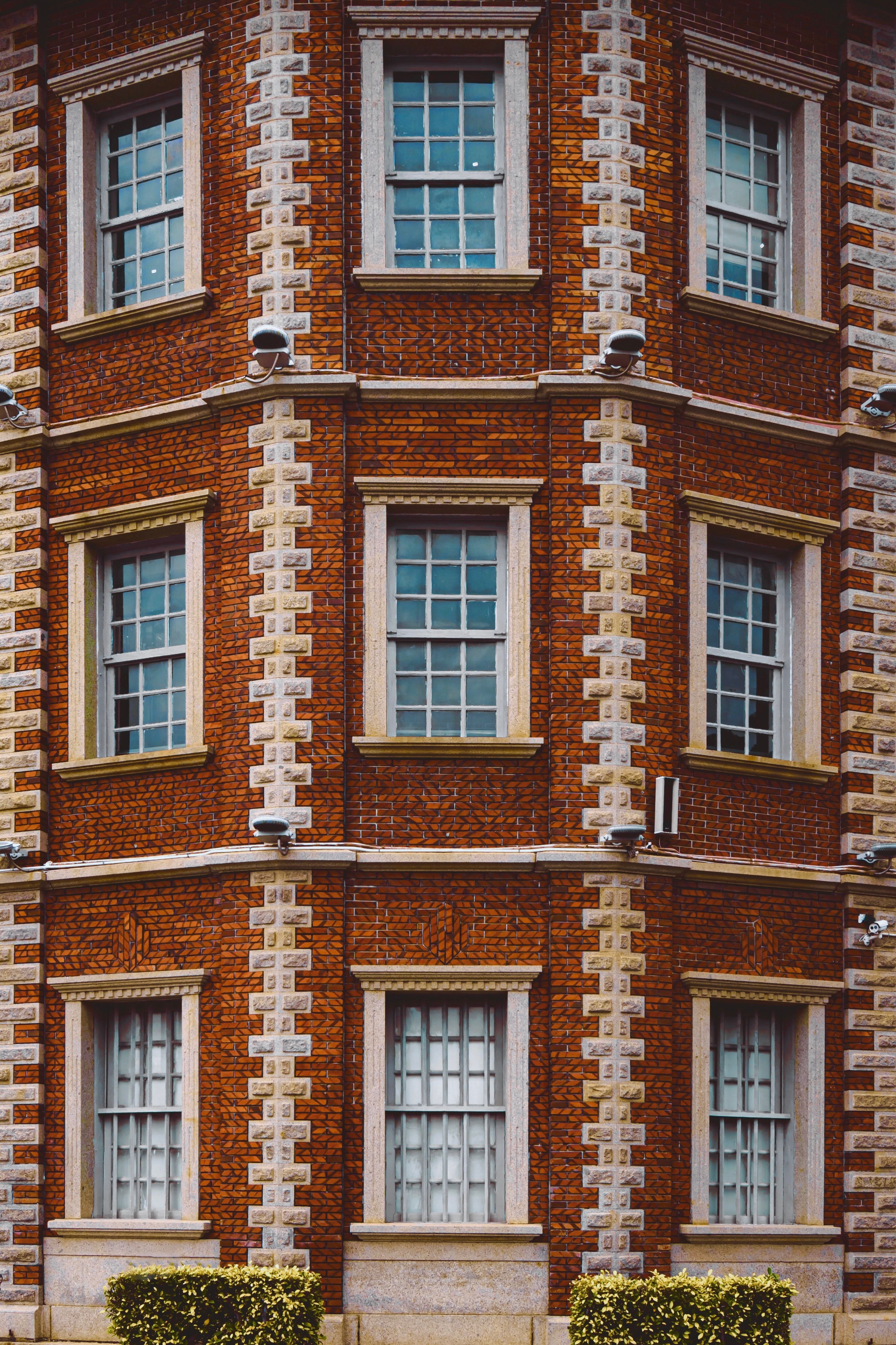 Symmetrical Brick Building Facade with Windows · Free Stock Photo