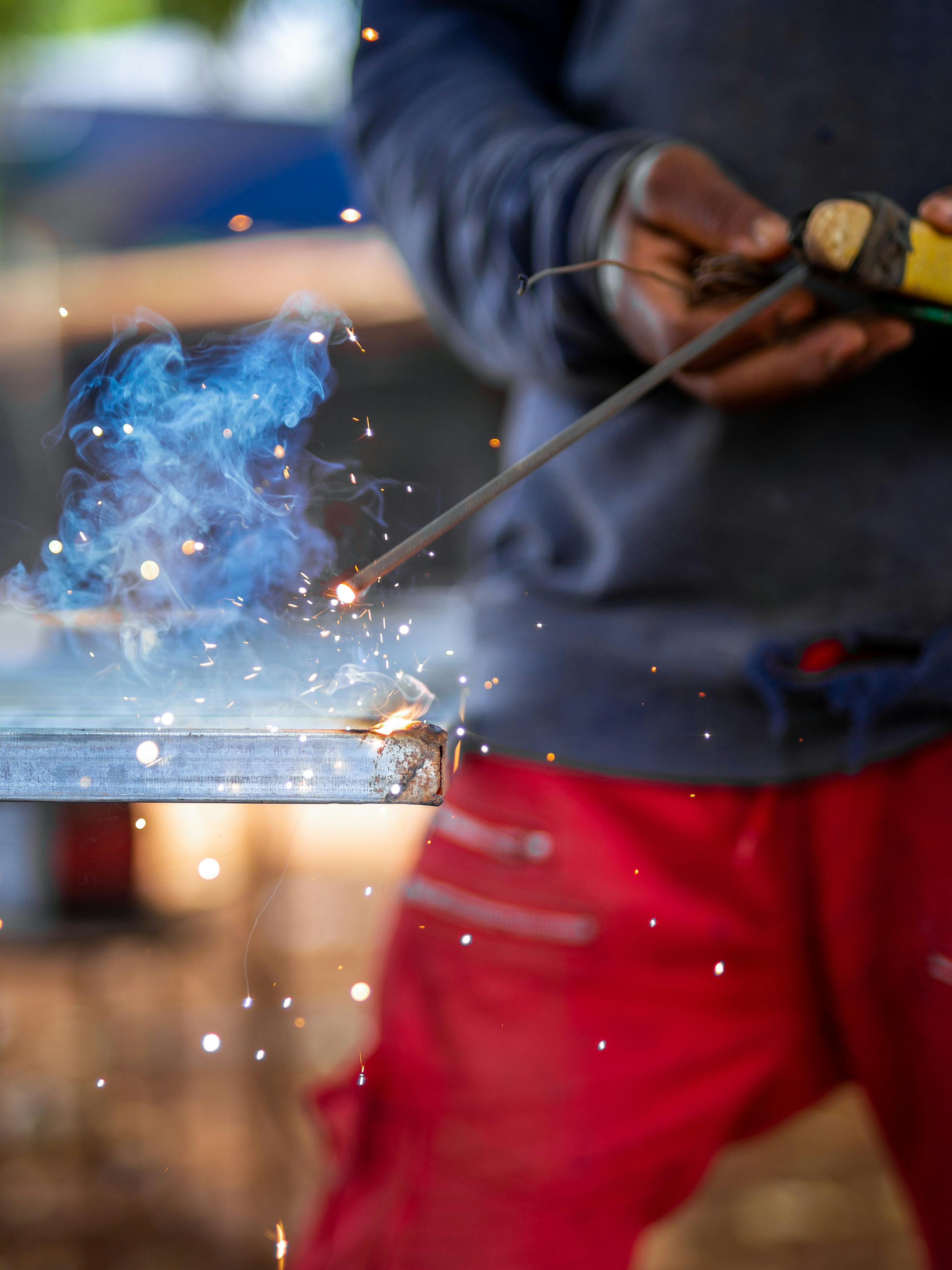 Dynamic Welding Scene with Sparks and Smoke · Free Stock Photo