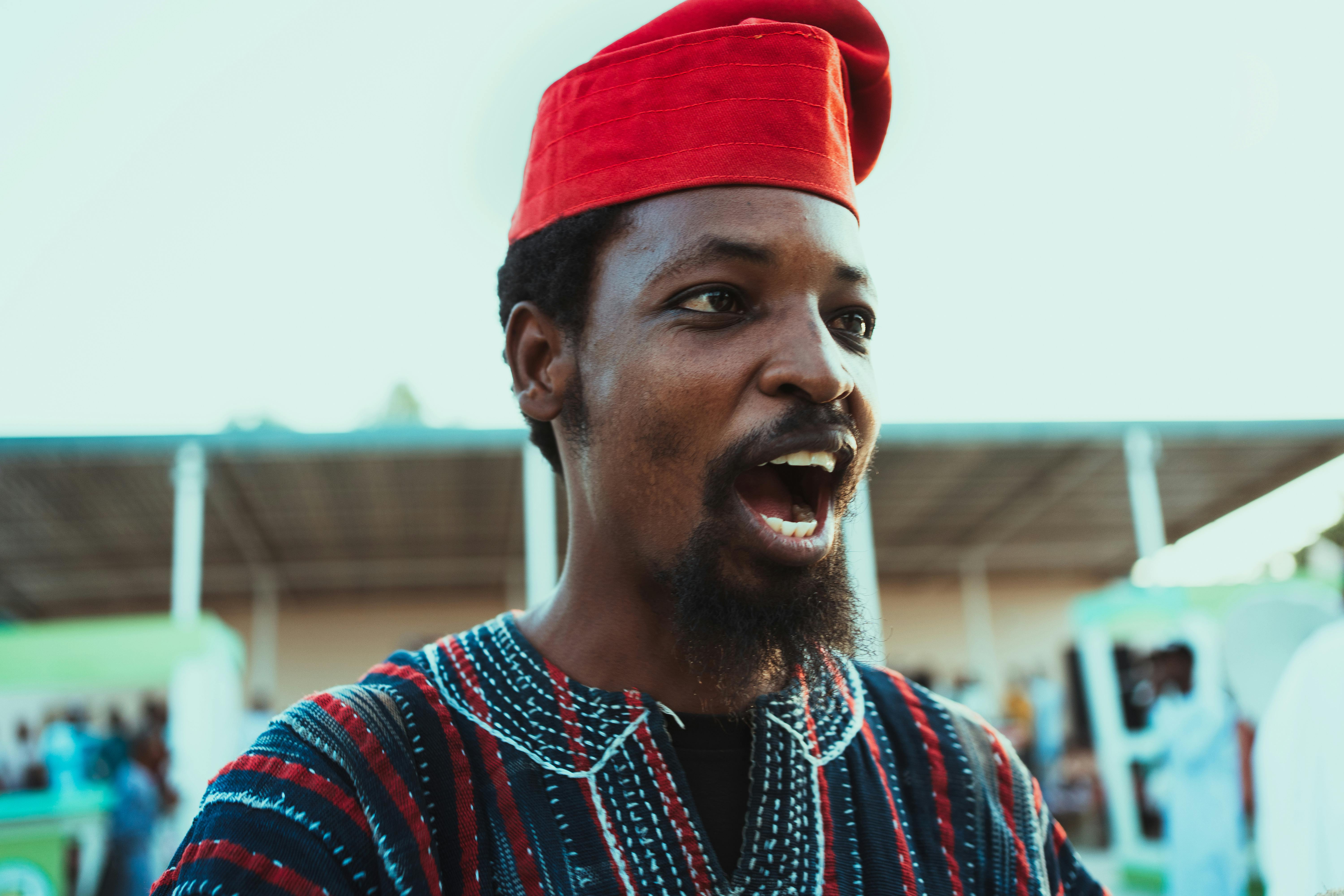 Nigerian Man in Traditional Red Cap Celebrating · Free Stock Photo
