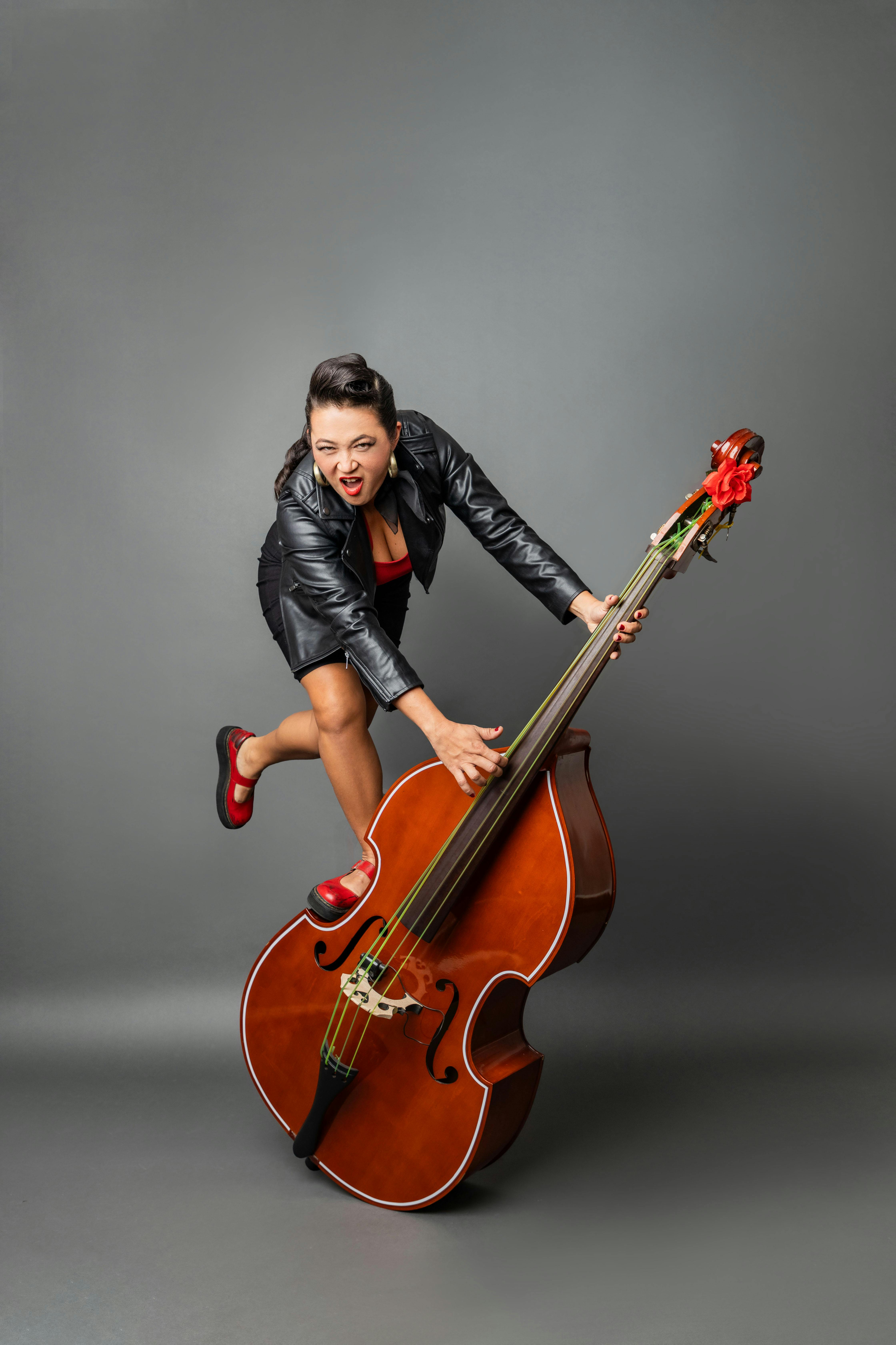 Dynamic Woman Playing Upright Bass Enthusiastically · Free Stock Photo