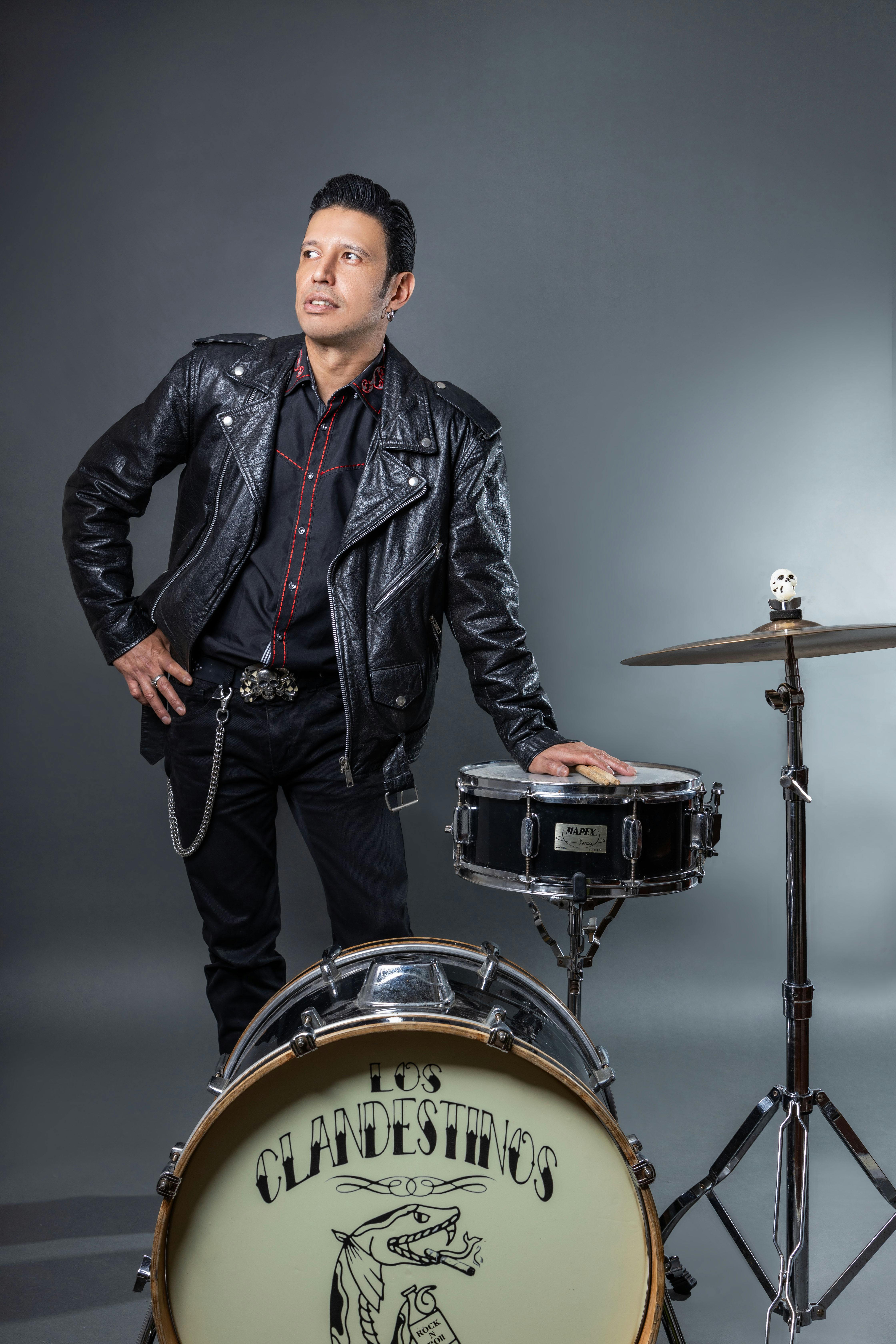 Portrait of a Drummer with Drum Kit in Studio · Free Stock Photo