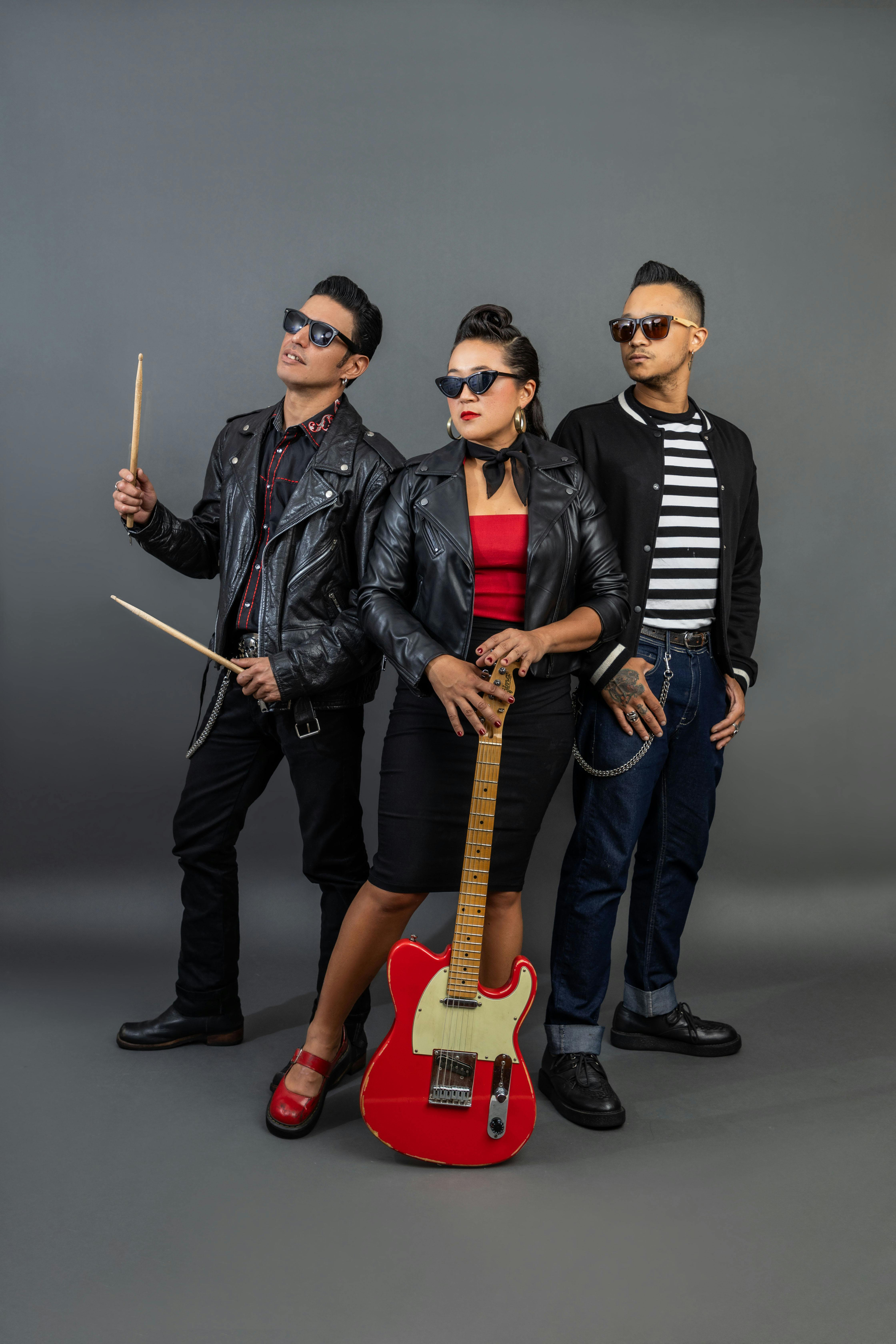 Stylish Band with Guitar and Drums in Studio · Free Stock Photo